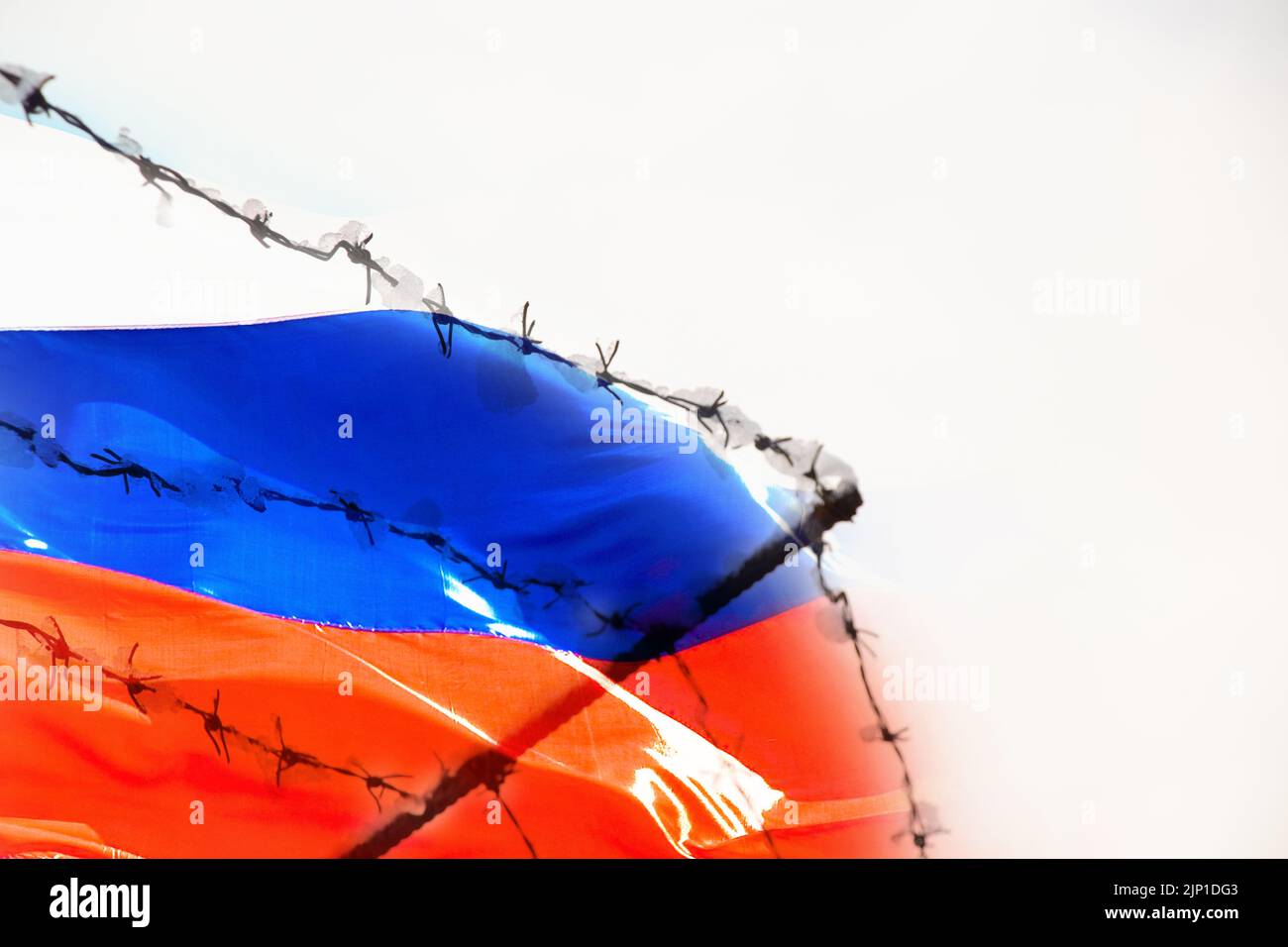 Flag of Russia on the background of barbed wire. Martial law in Ukraine ...