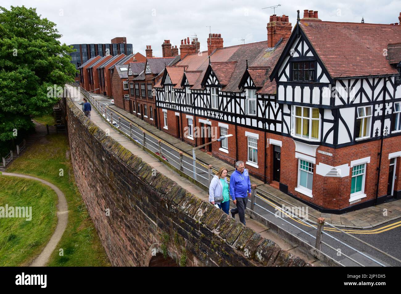 Chester, UK: Jul 3, 2022: Tourists enjoy a walk along the Roman Chester ...