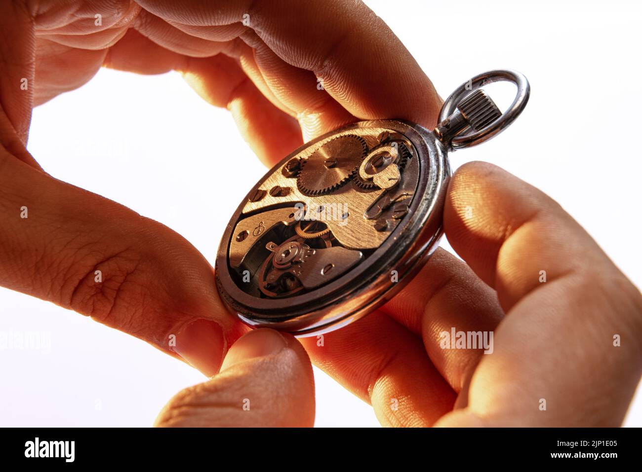 Closeup watchmaker's hands repairing mechanical watches isolated over ...