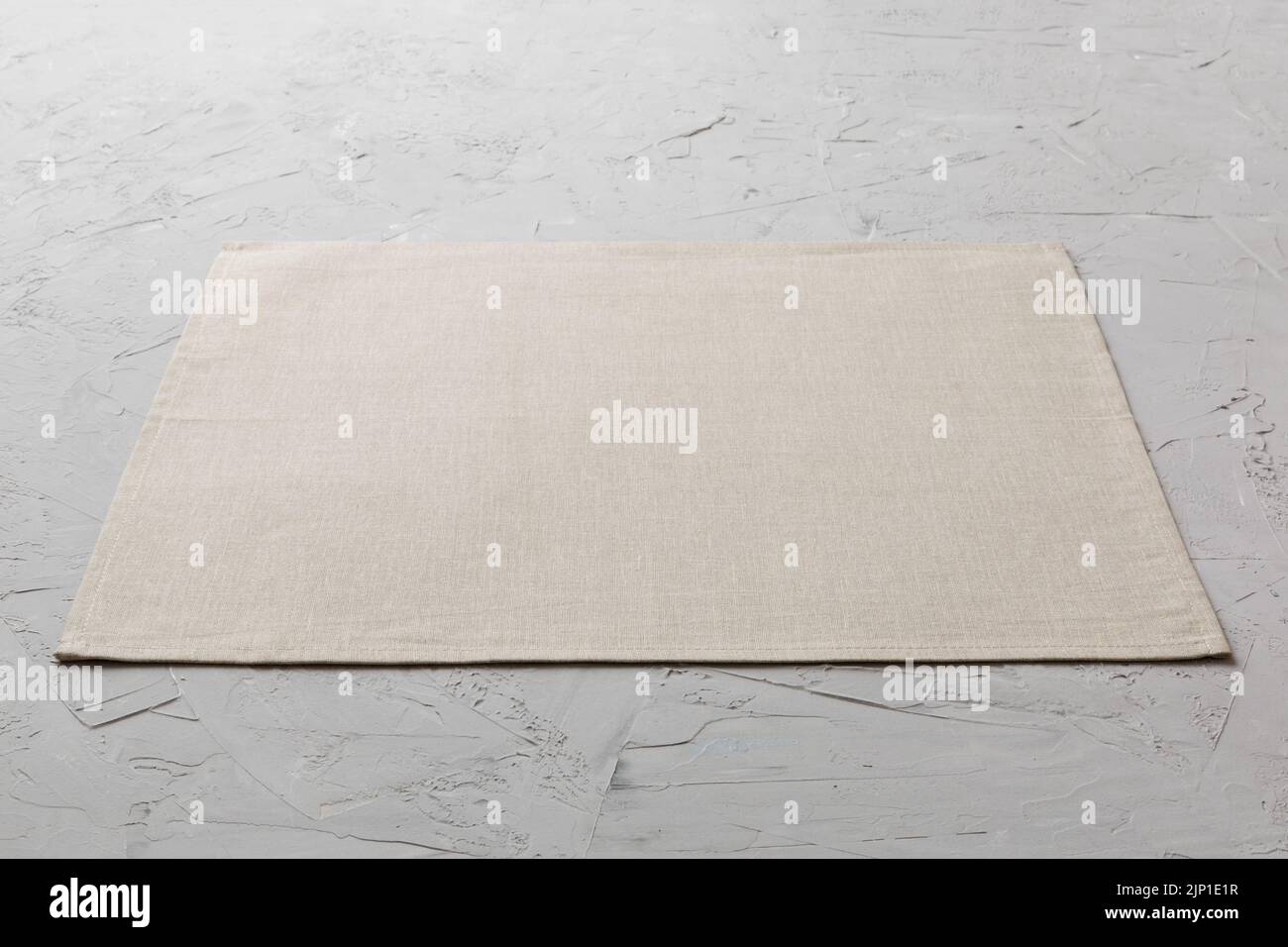 Perspective view of grey tablecloth for food on cement background ...