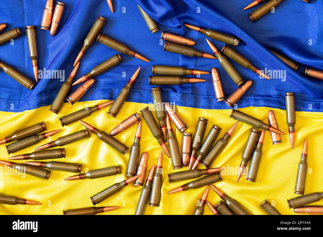Bullets lie on the yellow-blue flag of Ukraine, war in Ukraine, defense ...