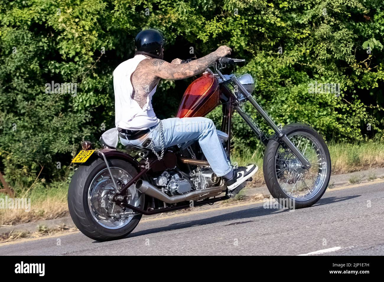 Heavily tattooed man riding a 1985 Harley Davidson Stock Photo - Alamy