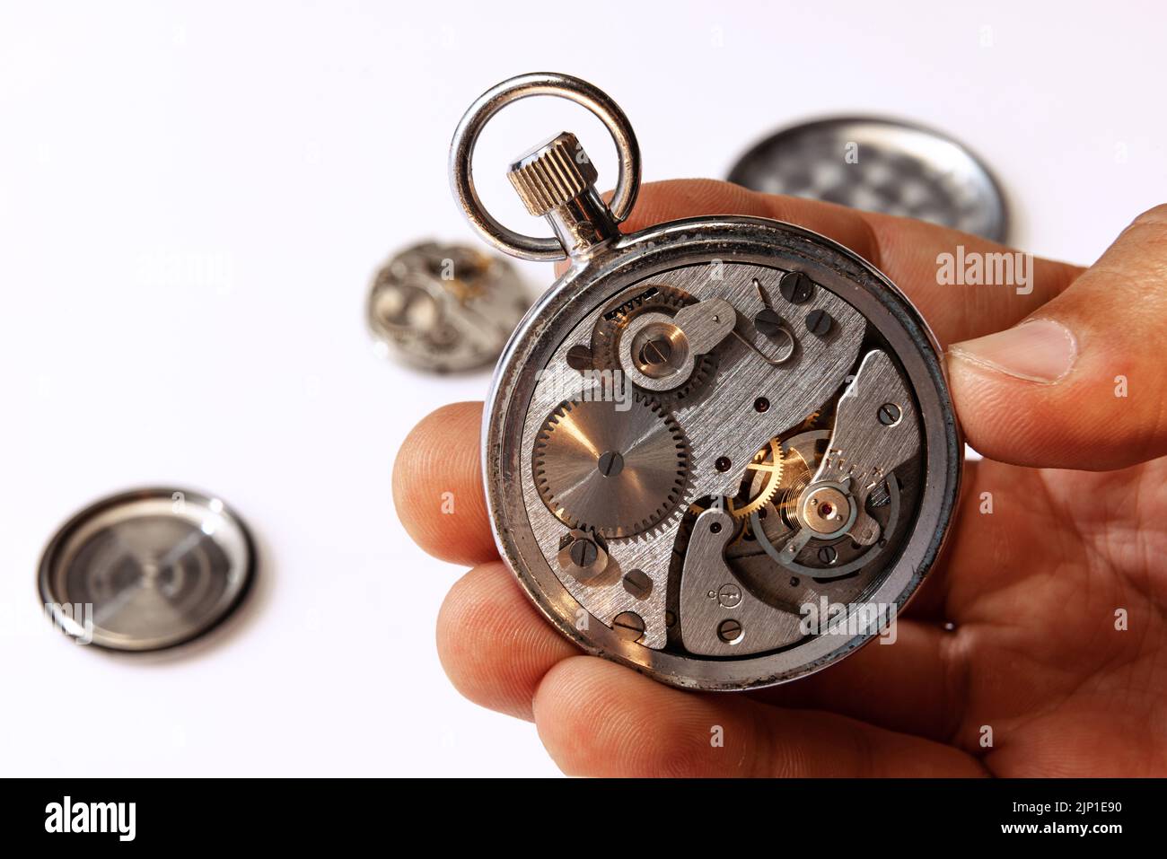 Closeup watchmaker's hands repairing mechanical watches isolated over ...