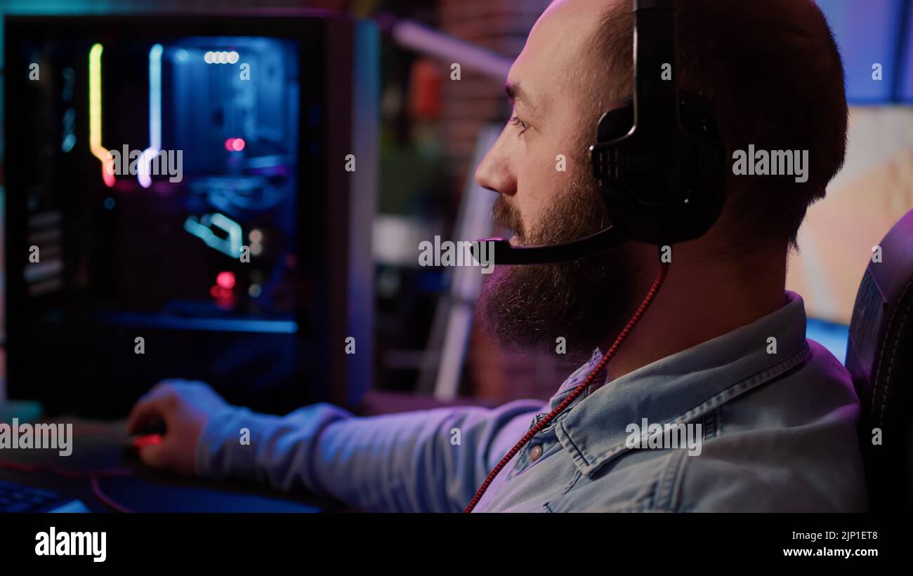Extreme closeup of man using headset talking into microphone with team ...