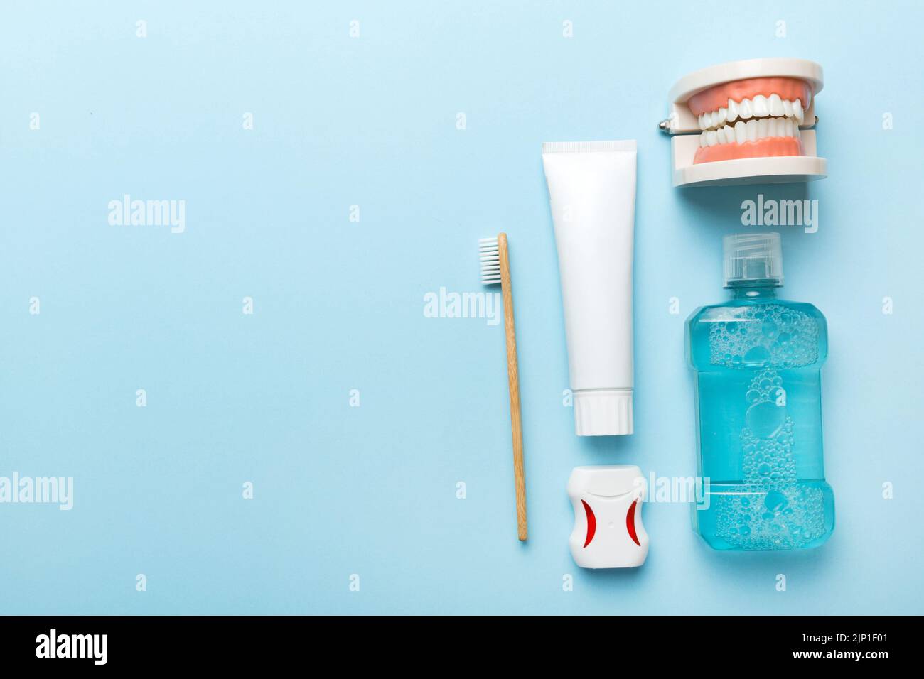 Mouthwash and other oral hygiene products on colored table top view ...