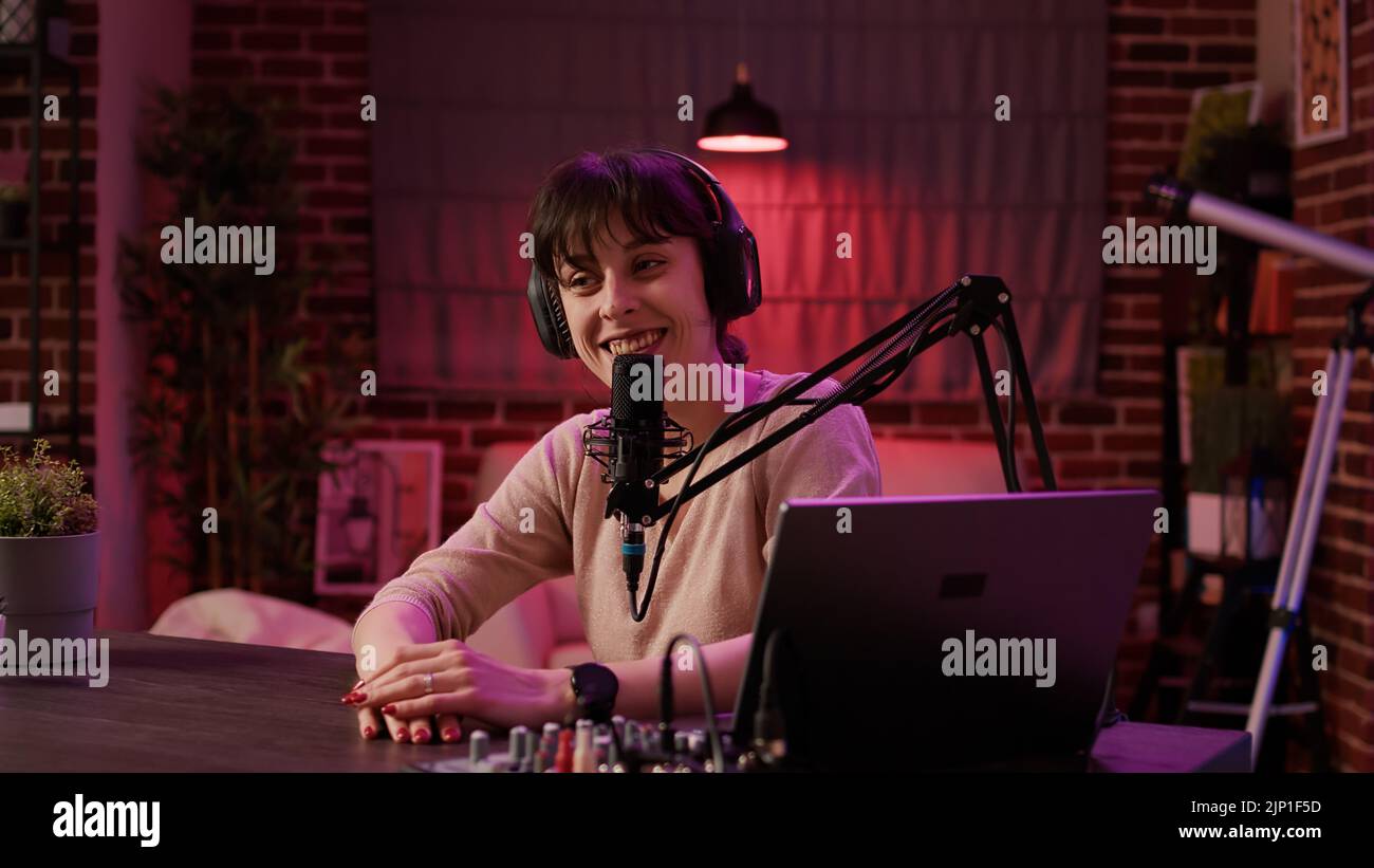Portrait of woman broadcasting internet radio entertainment show while ...