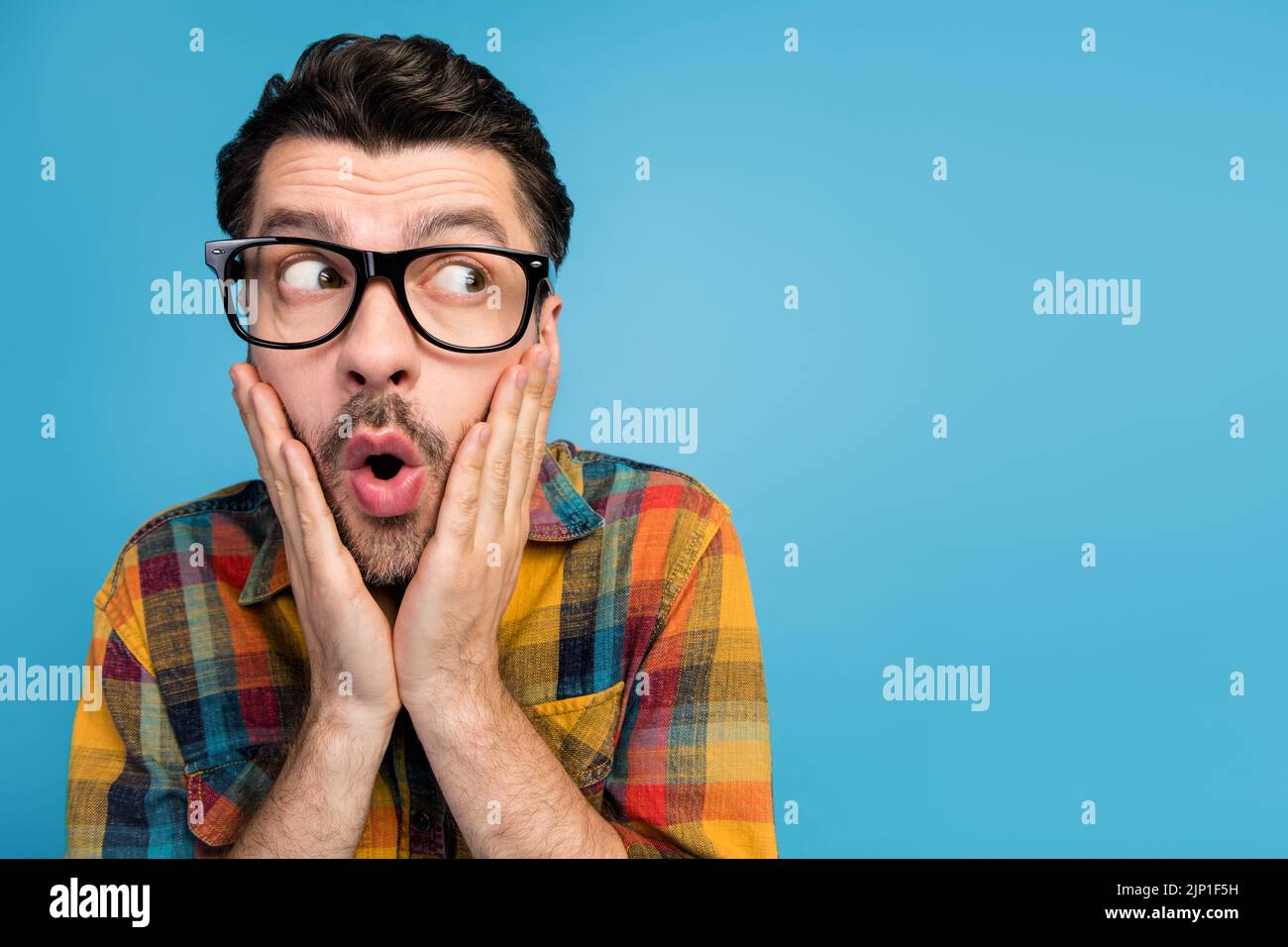 Photo of speechless handsome excited guy in eyewear dressed plaid shirt ...