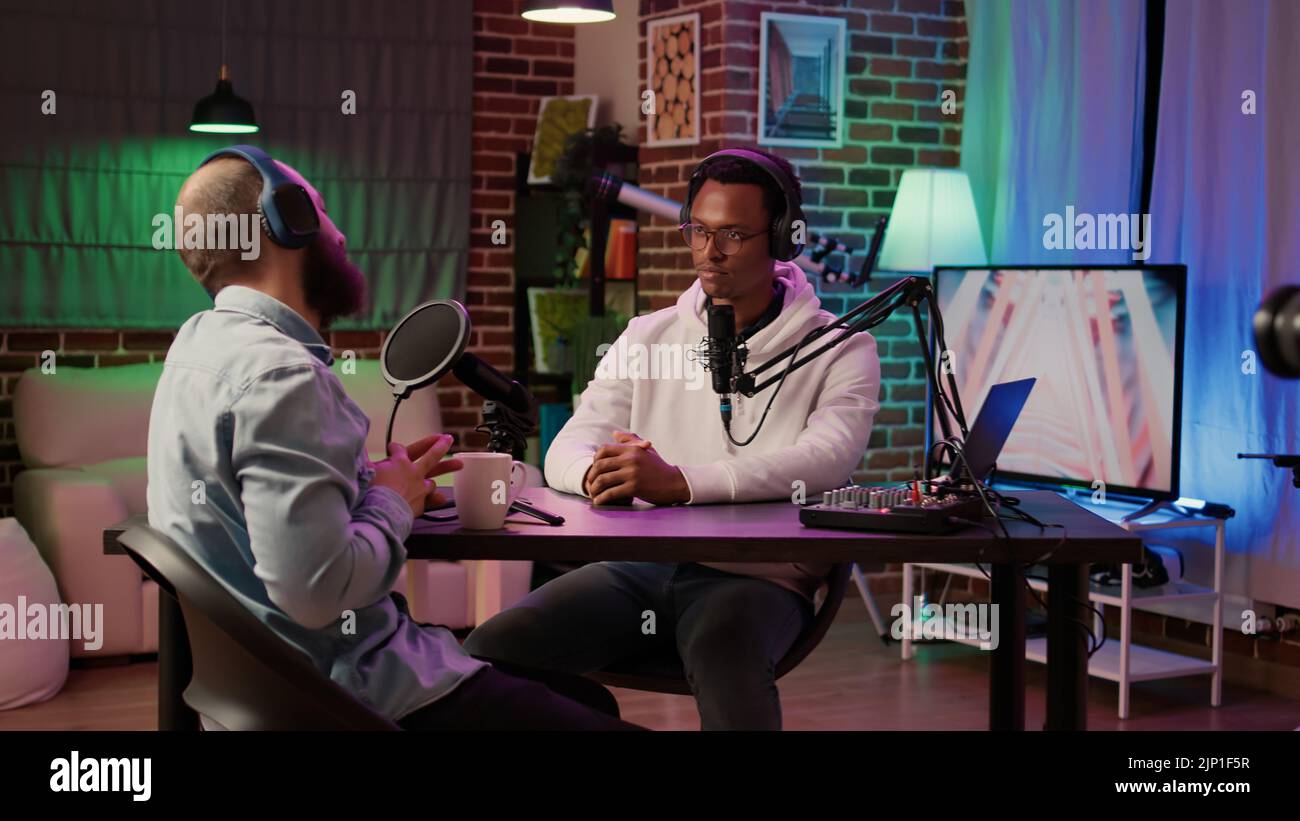 Internet radio host greeting guest doing fist bump hand gesture while ...