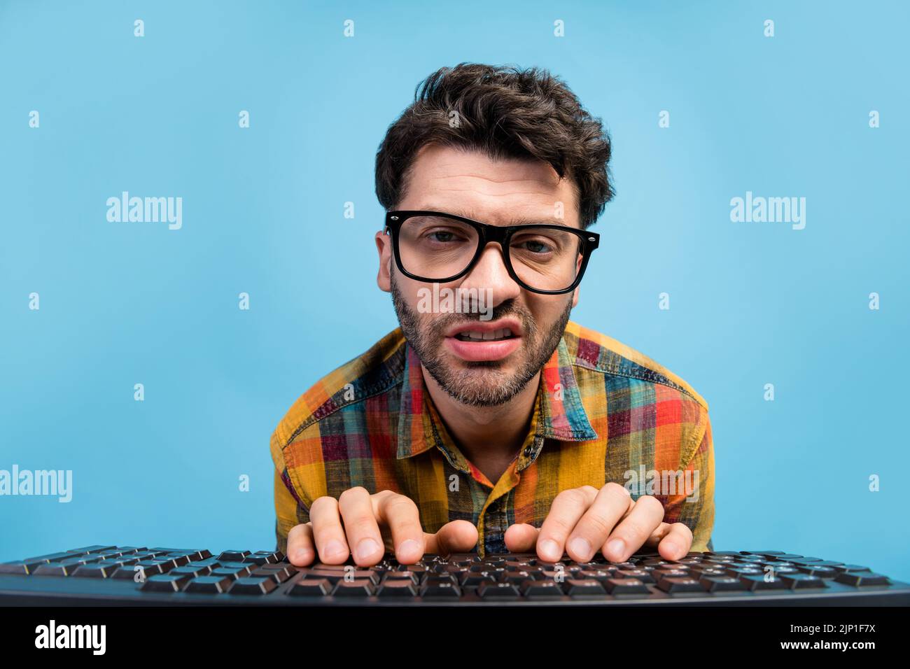 Photo of sad brunet guy type keyboard wear eyewear checkered shirt ...