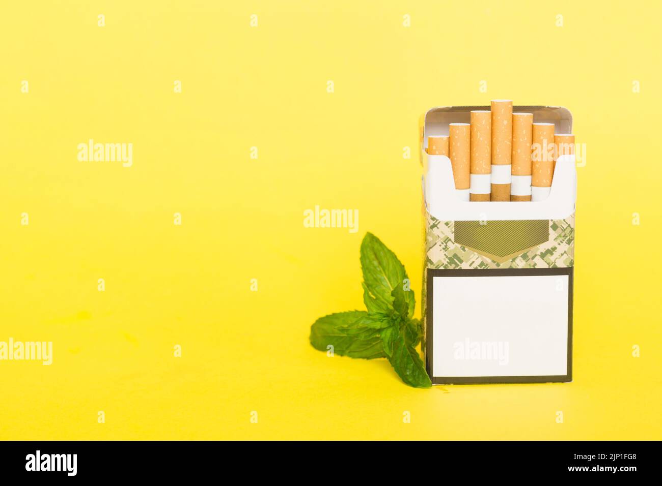 Pack of menthol cigarettes and fresh mint on colored table, Menthol ...