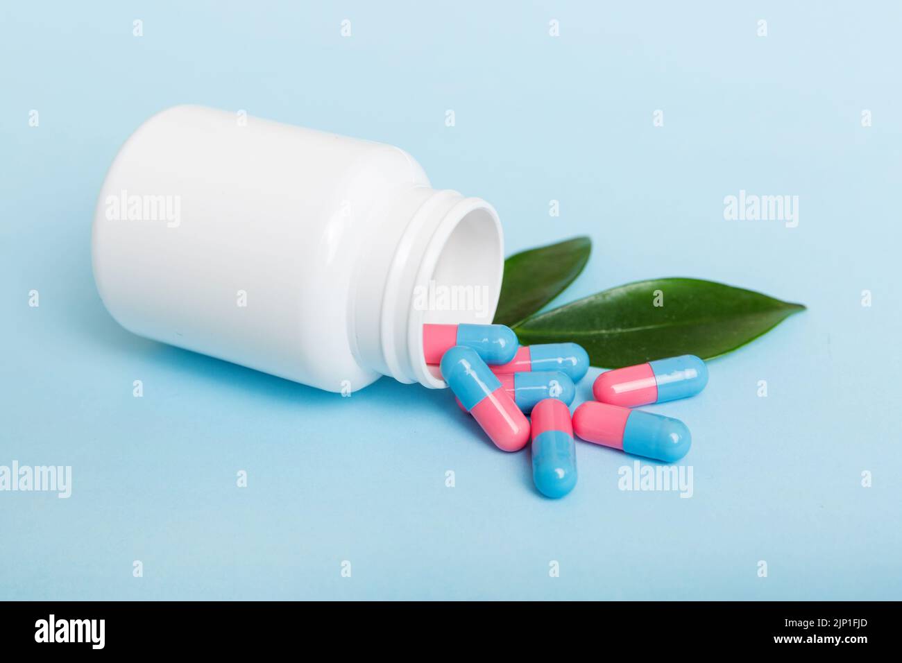 different drugs and health supplement pills poured from a medicine ...