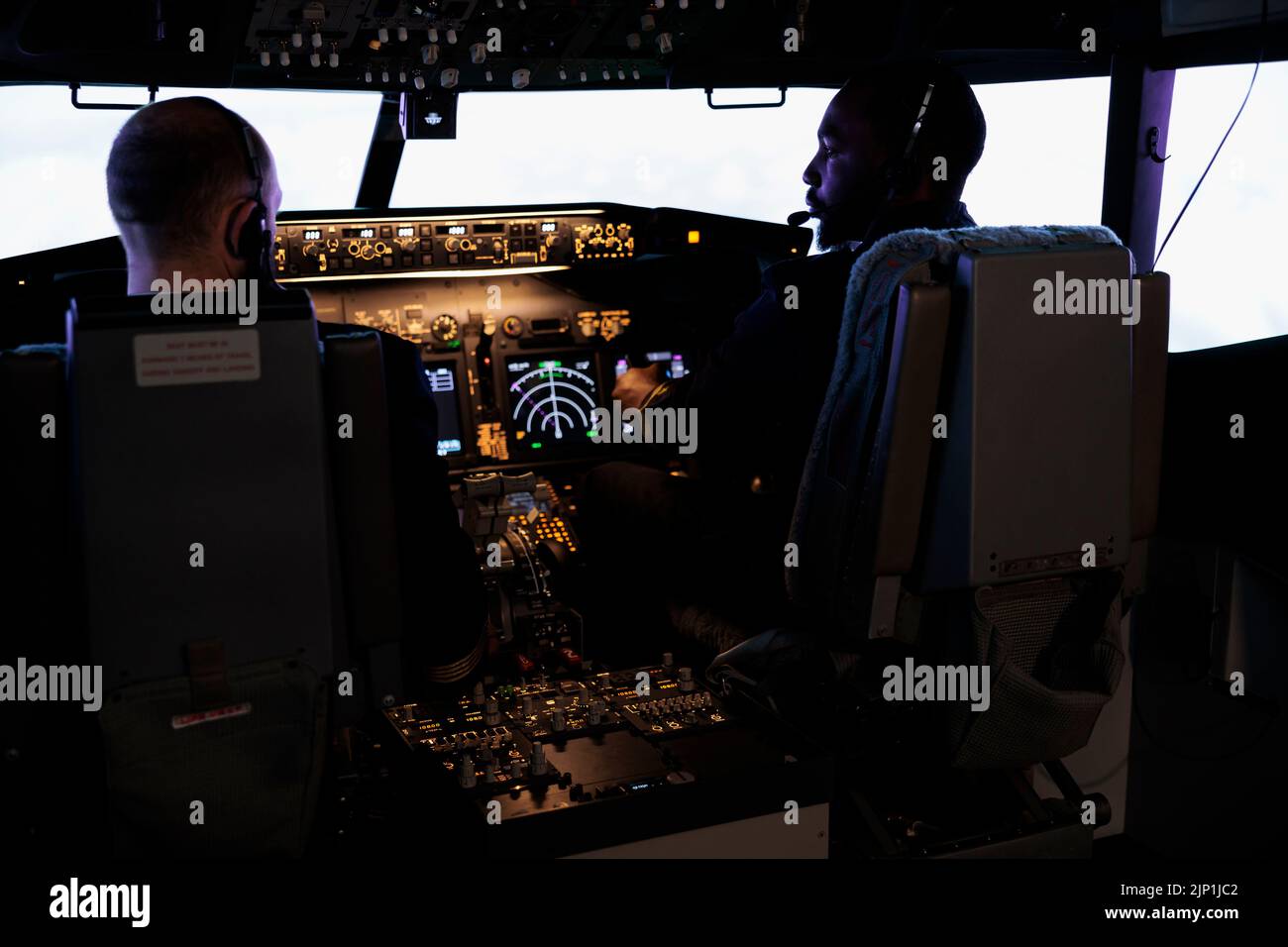 Captain and pilot flying airplane with engine lever and power switch on ...