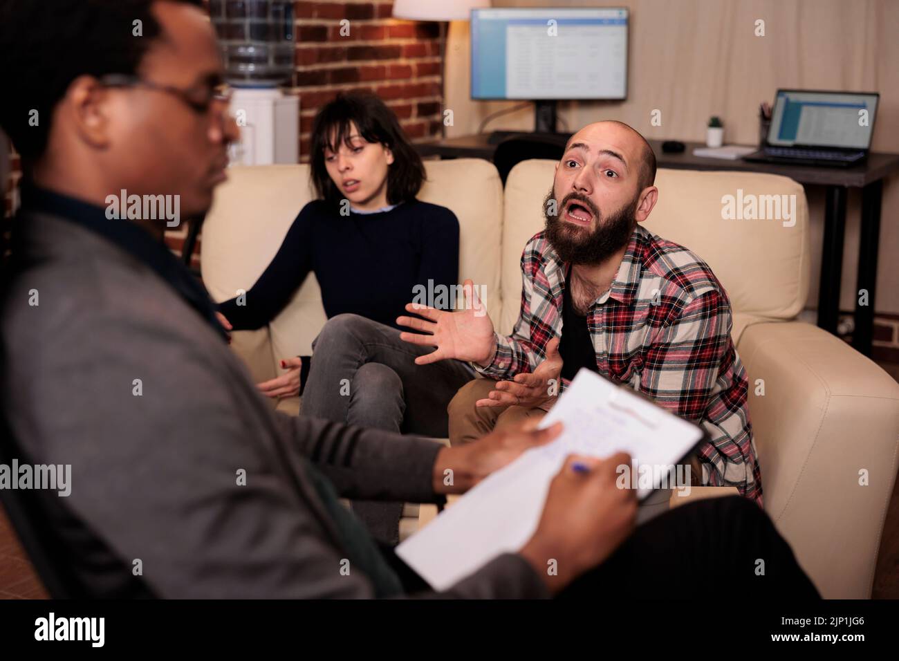 Professional counselor doing psychoanalysis of people at couple therapy ...