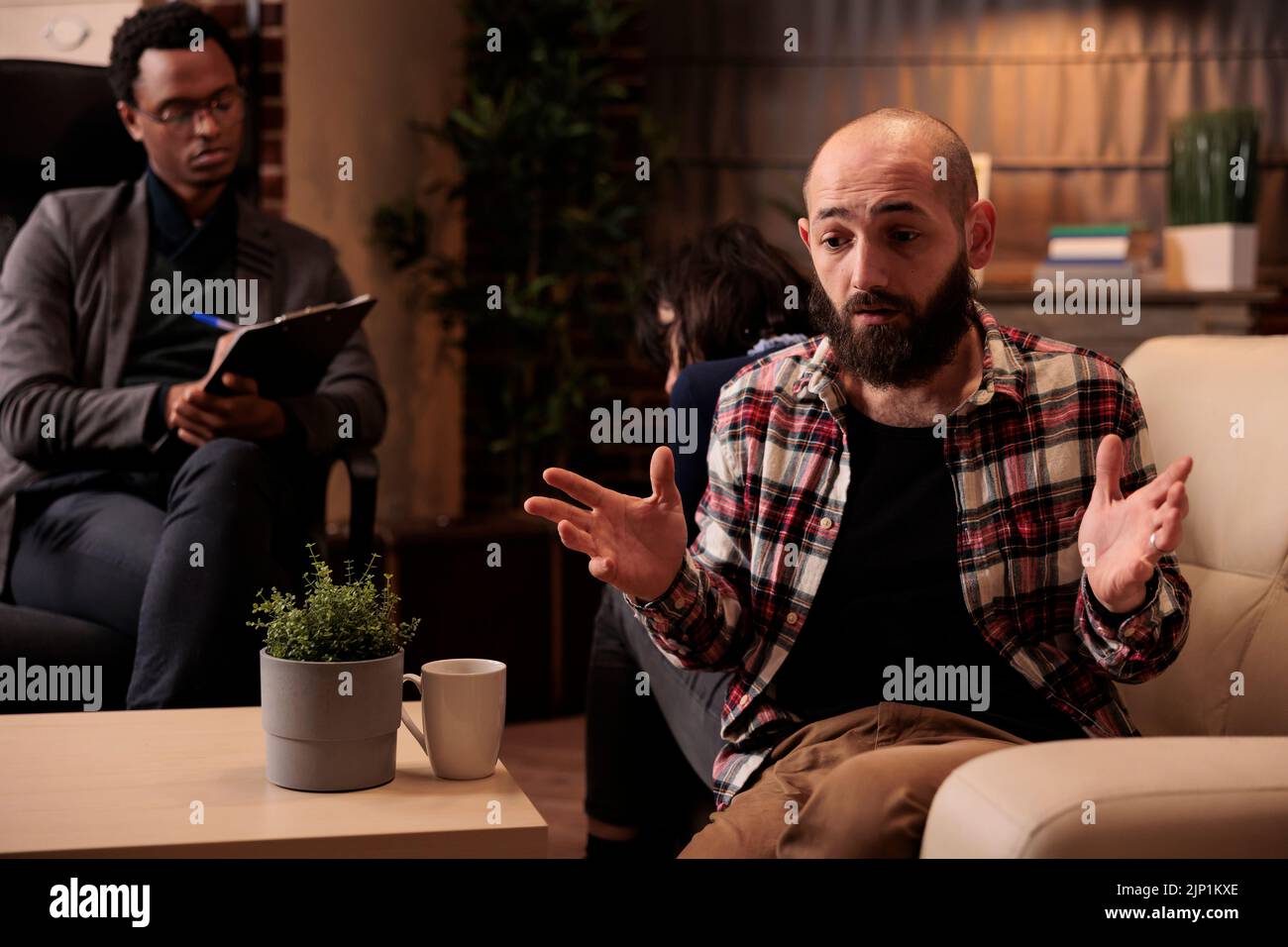 People sitting back to back arguing at couple therapy session with ...