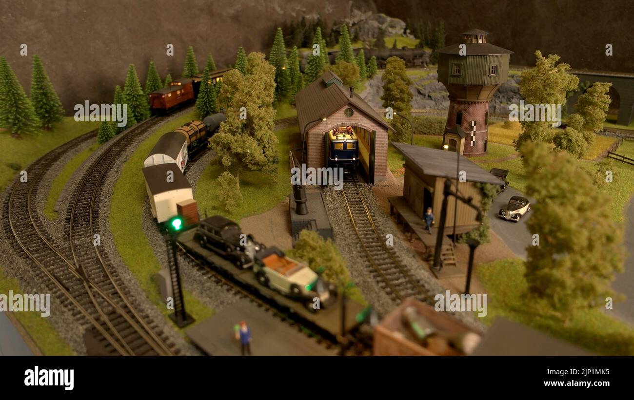 Mini train station modelling. Miniature model of train moving through ...