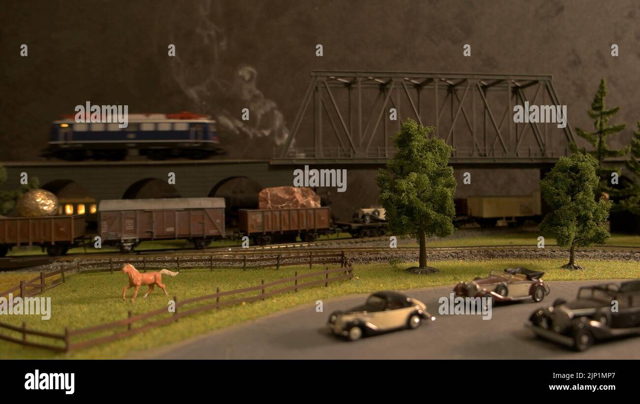 Model of steam locomotive train crossing the bridge. Model of freight ...