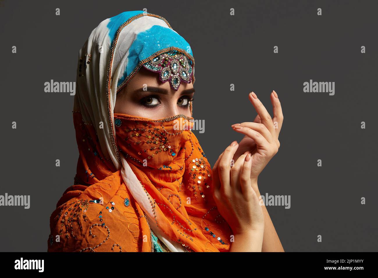 Studio shot of a chrming female wearing the colorful hijab decorated ...