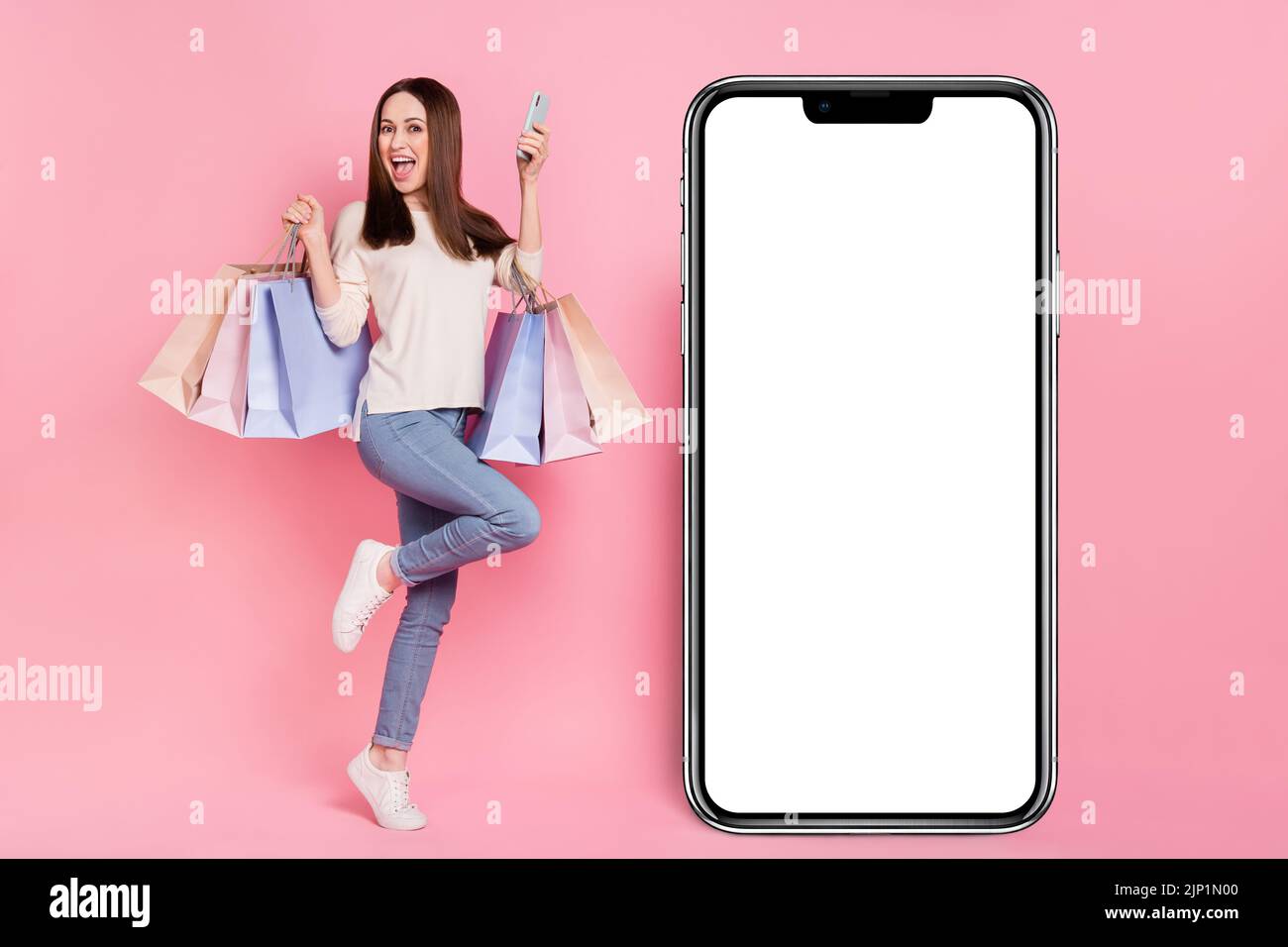 Fashionista girl vlogger hold boutique packages hold smart phone surf ...