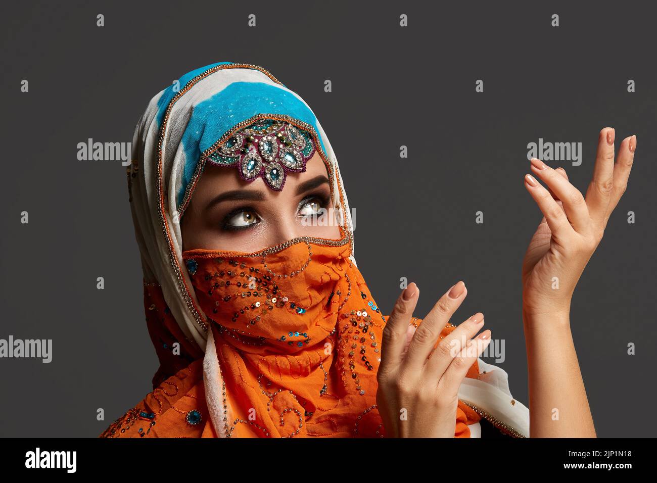 Studio shot of a chrming female wearing the colorful hijab decorated ...
