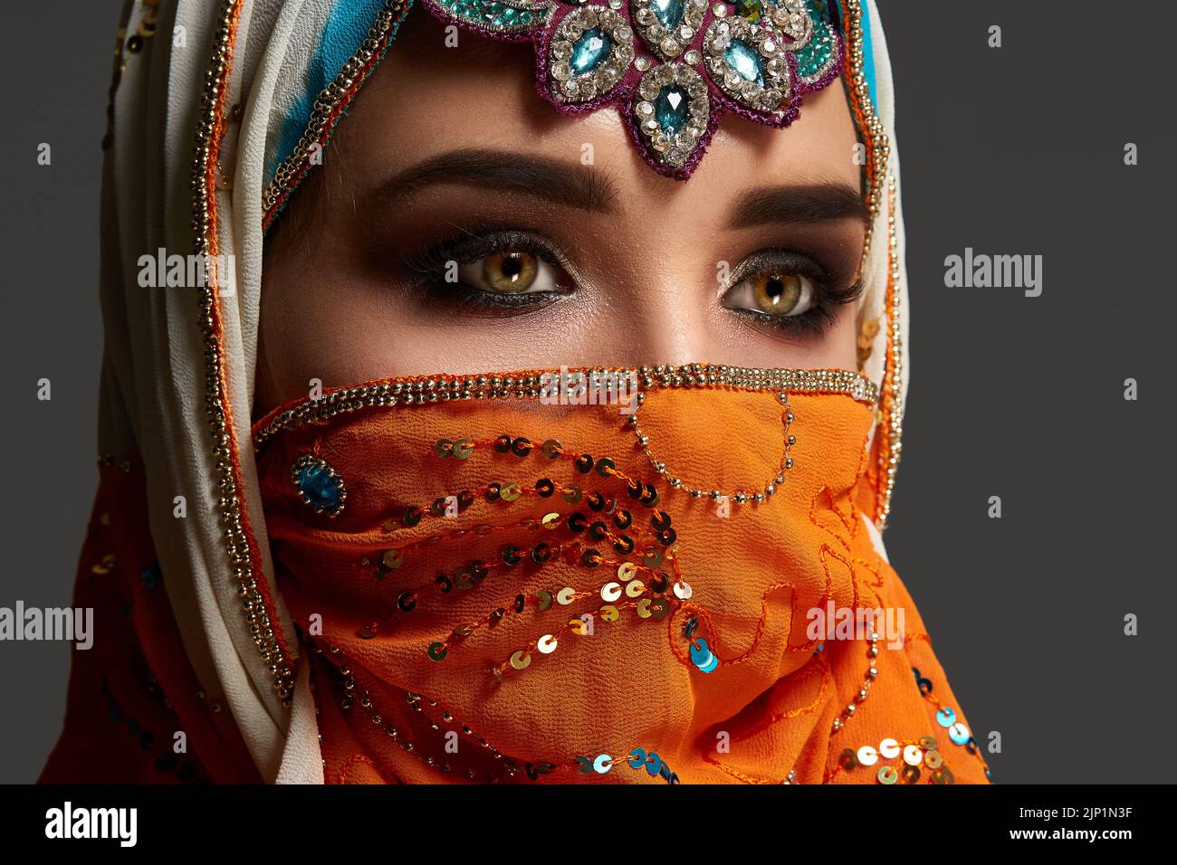 Studio shot of a chrming female wearing the colorful hijab decorated ...