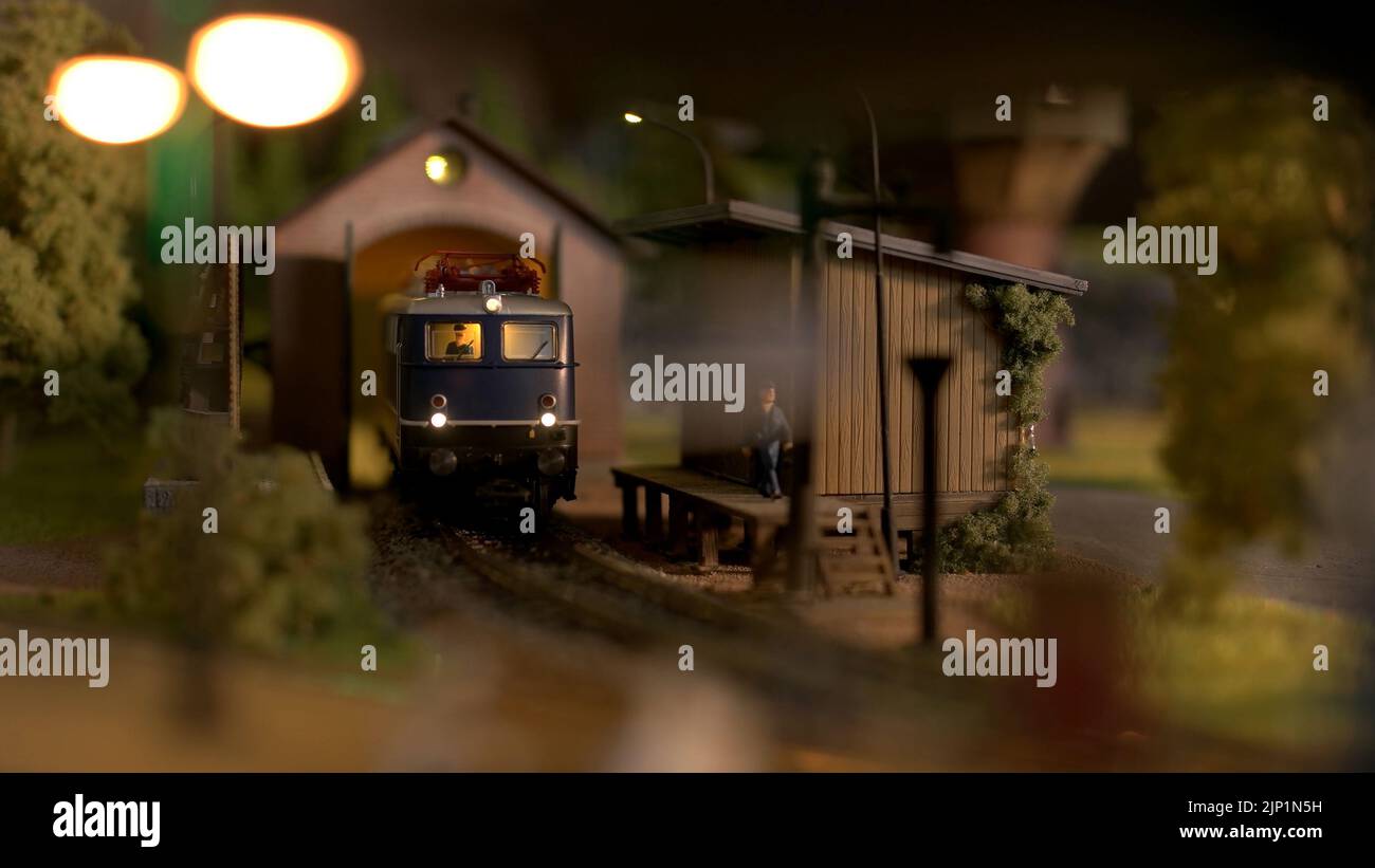 Toy diesel railway engine at depot station. Scale model railway layout ...
