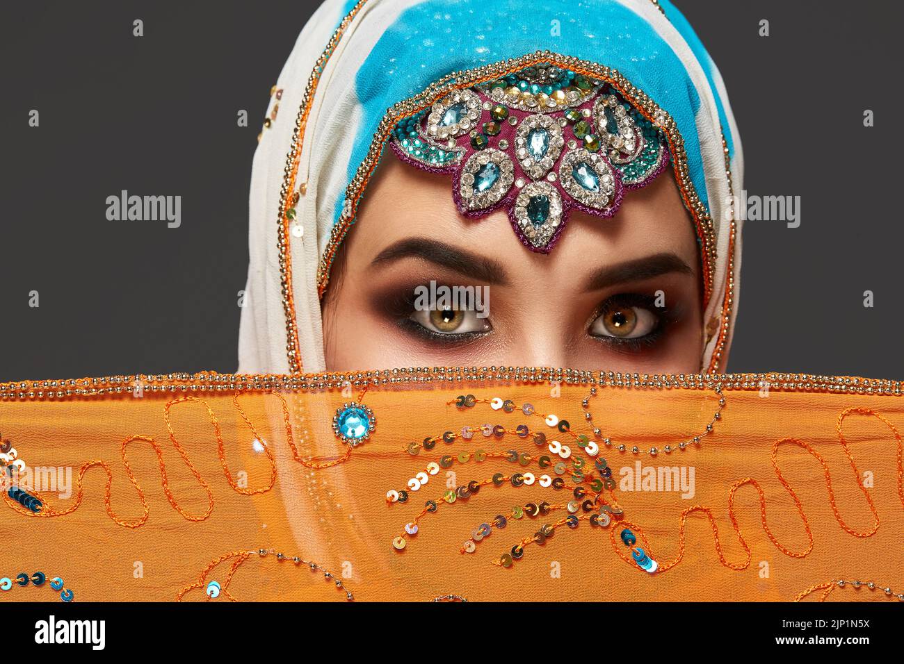 Studio shot of a chrming female wearing the colorful hijab decorated ...