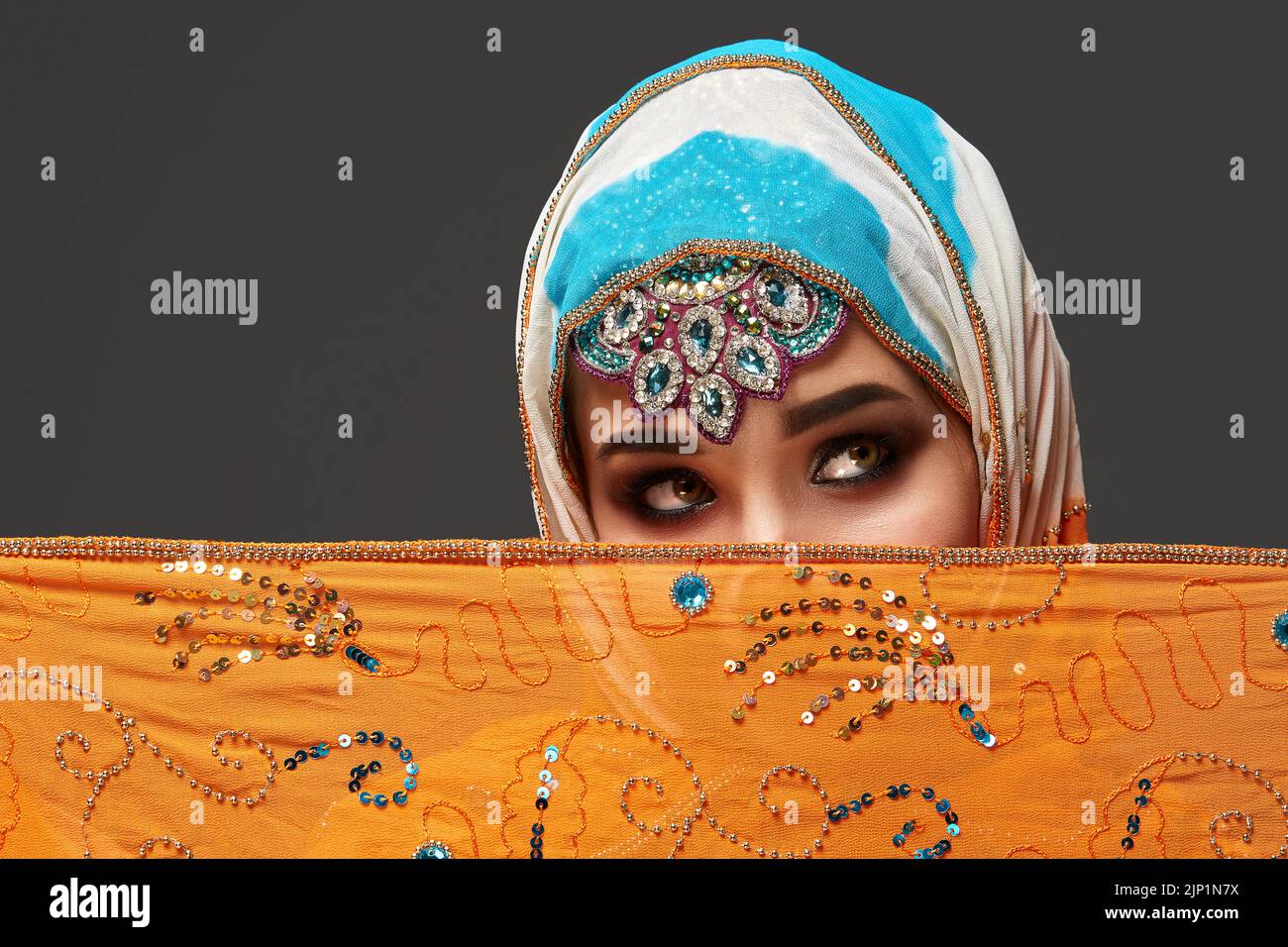 Studio shot of a chrming female wearing the colorful hijab decorated ...