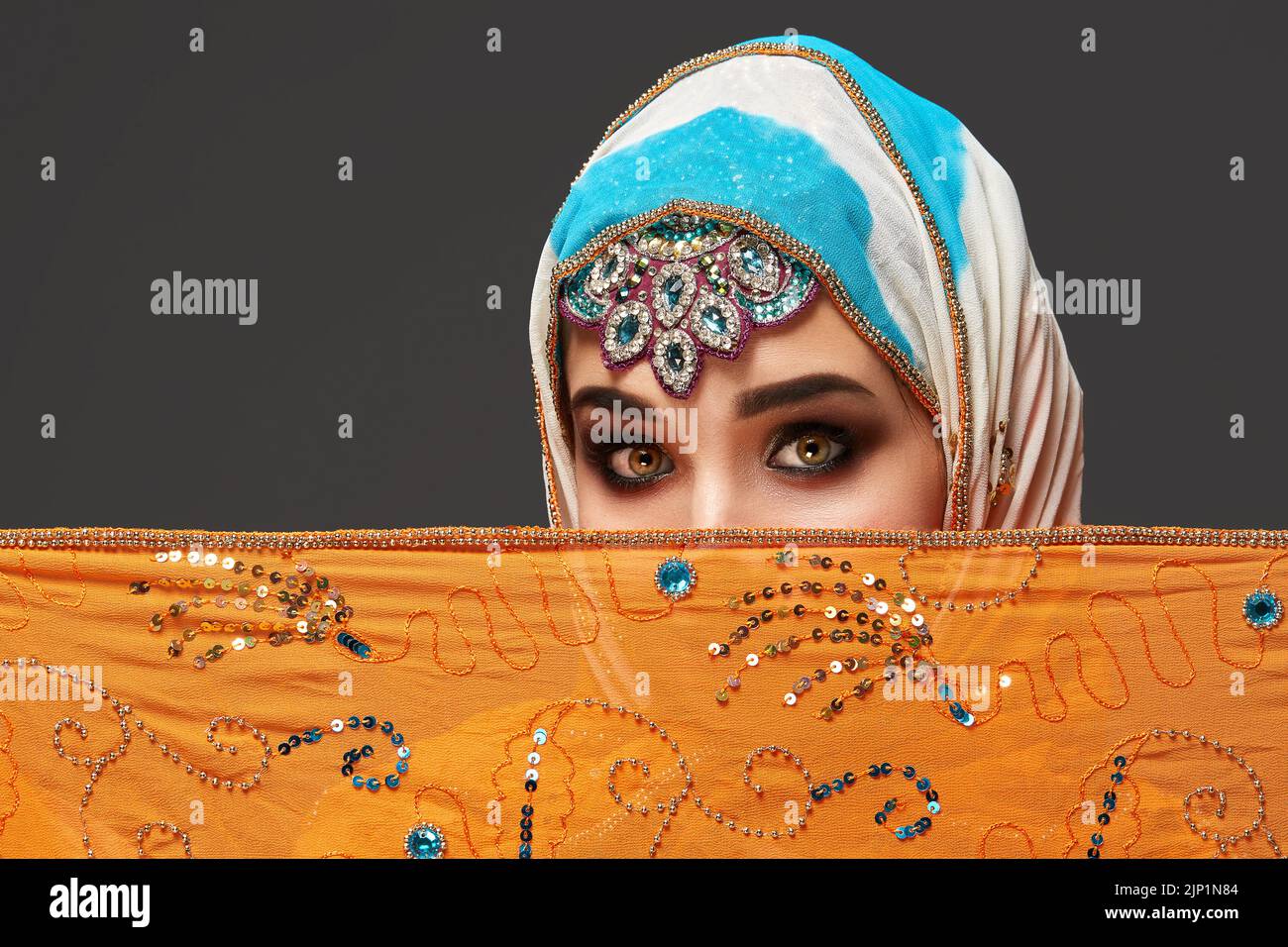Studio shot of a chrming female wearing the colorful hijab decorated ...
