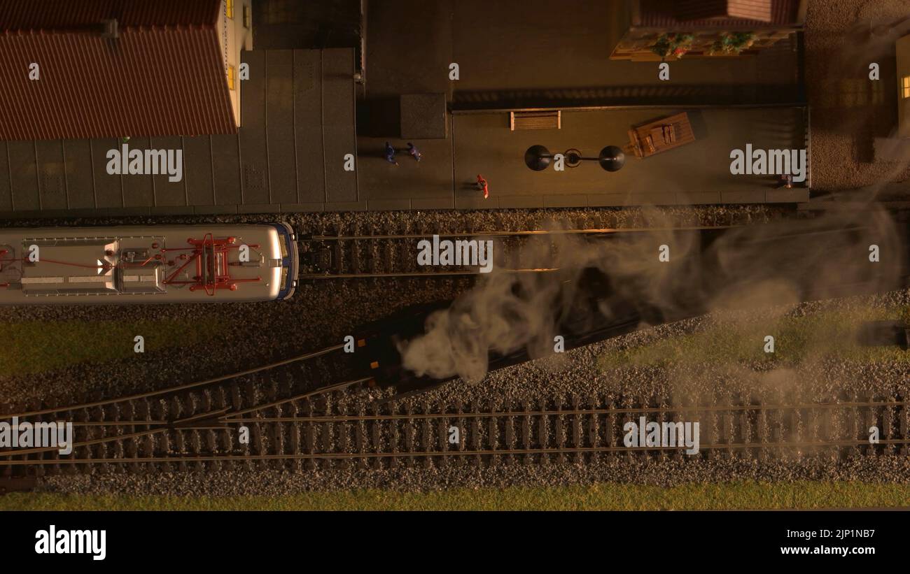 Top view of miniature of railway station. Steam locomotive and diesel locomotive moving on model ...