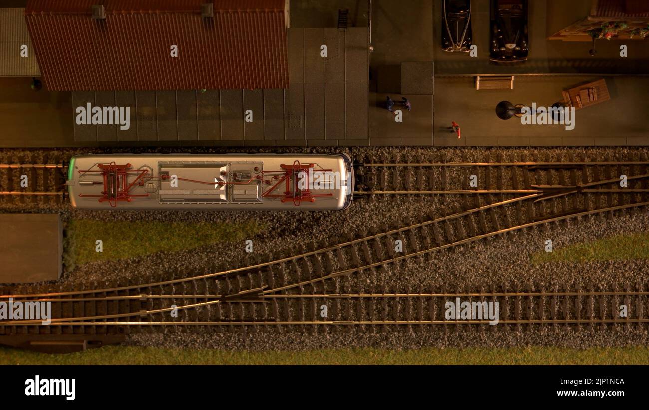 Diesel locomotive moving on model railroad. Top view of miniature of ...