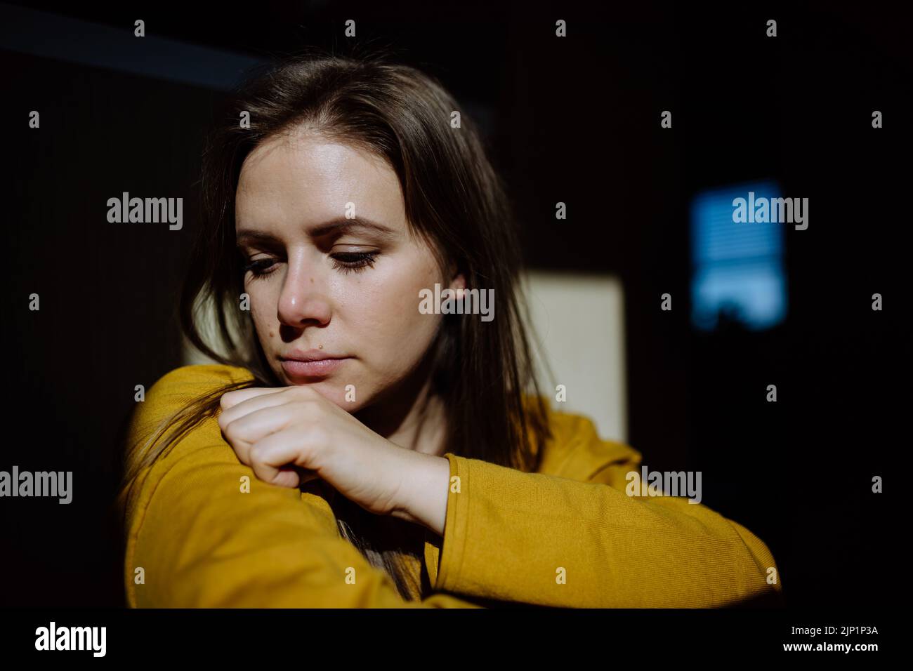 Woman suffering from depression at home, crying and looking trough the ...