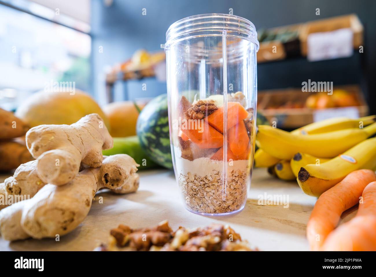 Healthy protein shake on table with fruits and vegetables ingredients ...