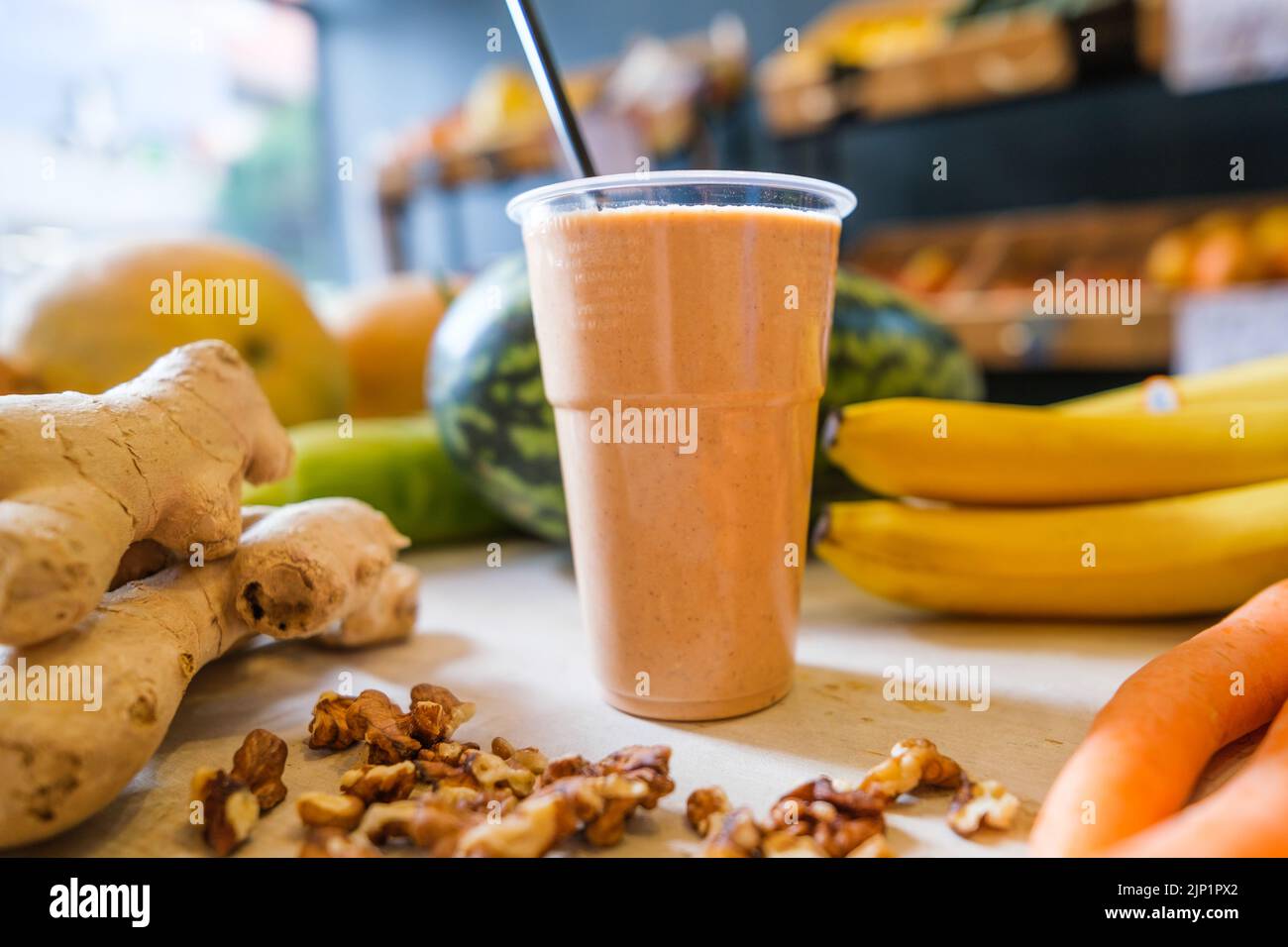 Healthy protein shake on table with fruits and vegetables ingredients ...