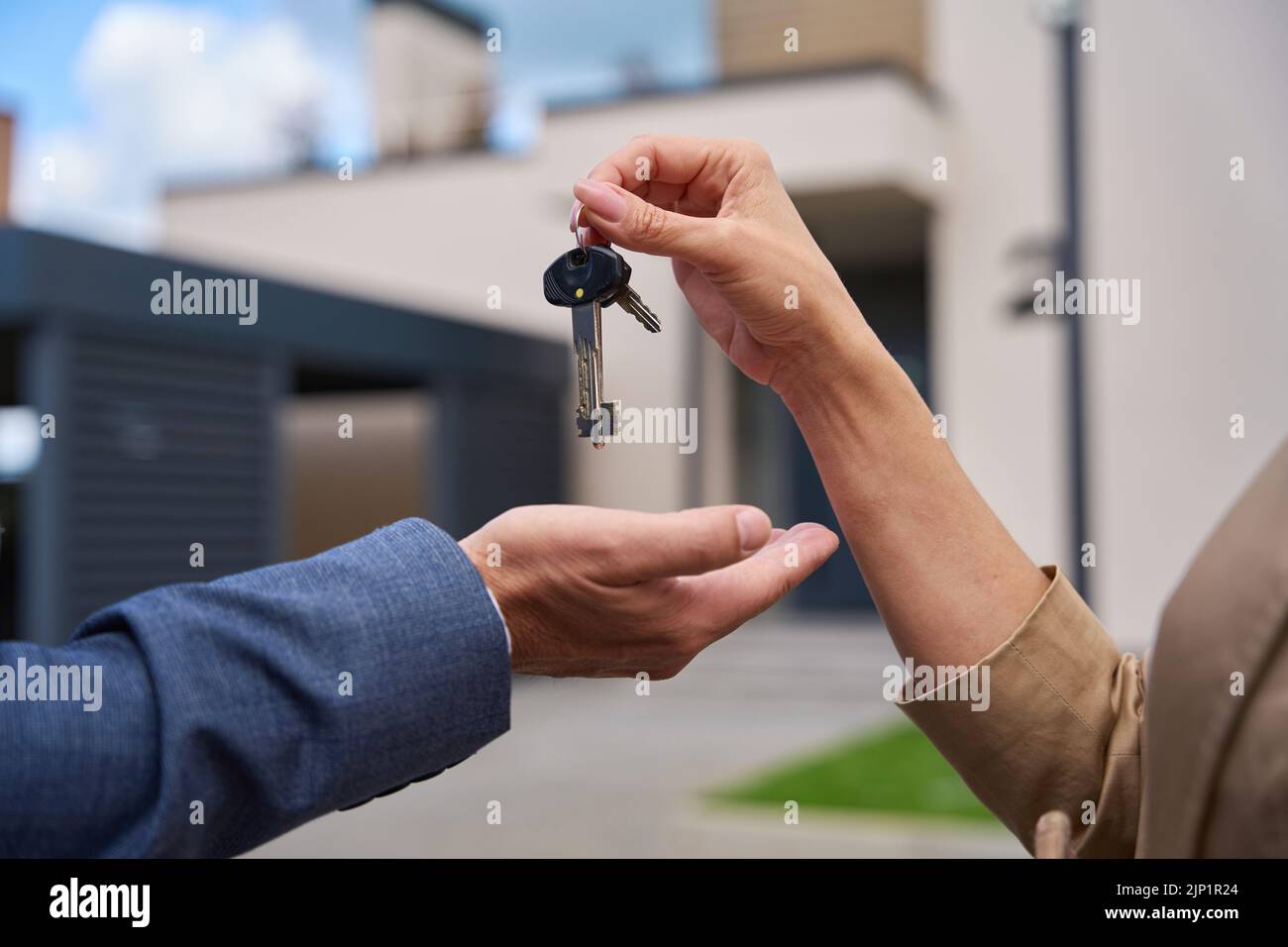 Close-up of woman hand passing keys to man hand Stock Photo - Alamy