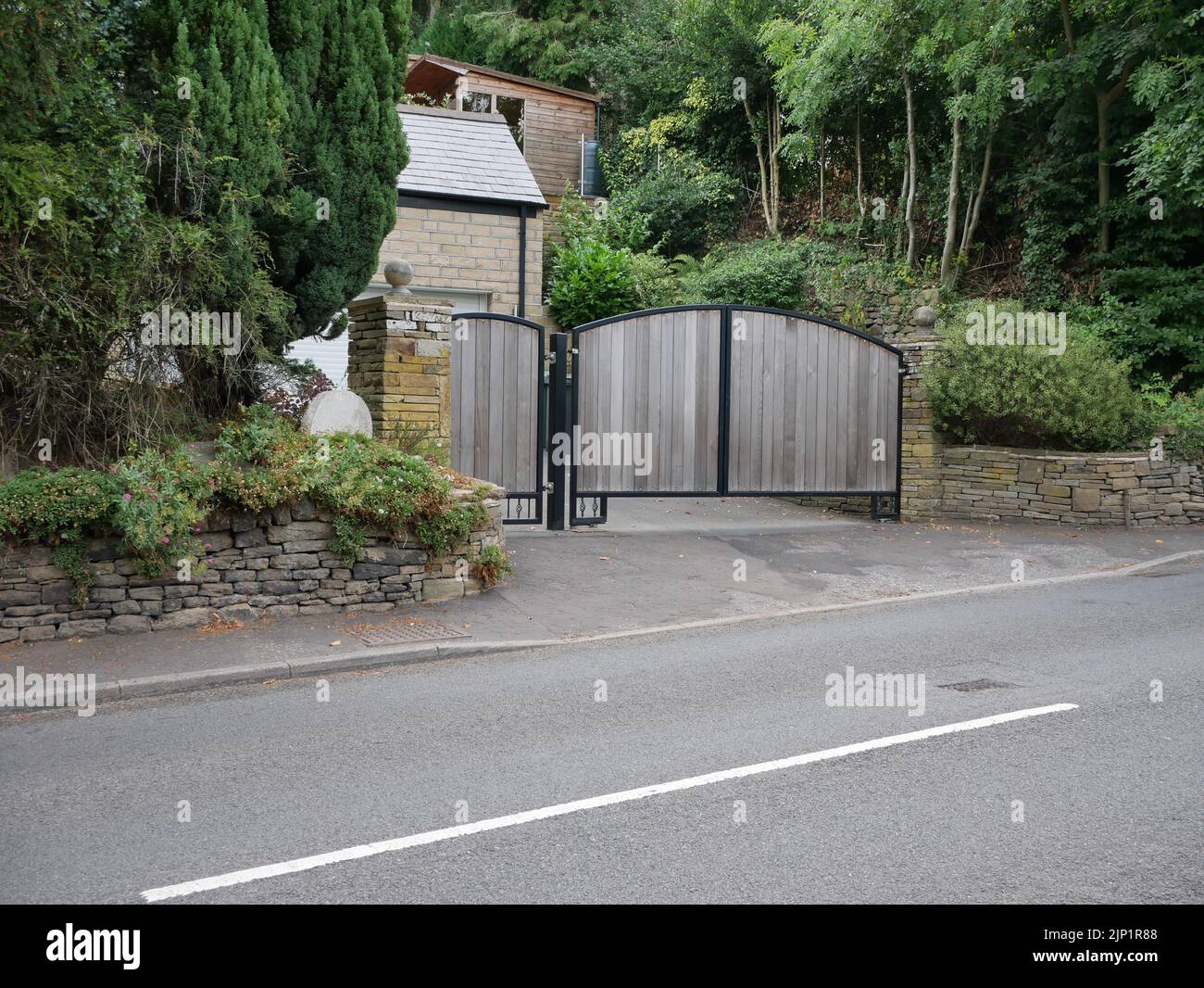 Roadside residential wood gates with vertical boards black metal ...