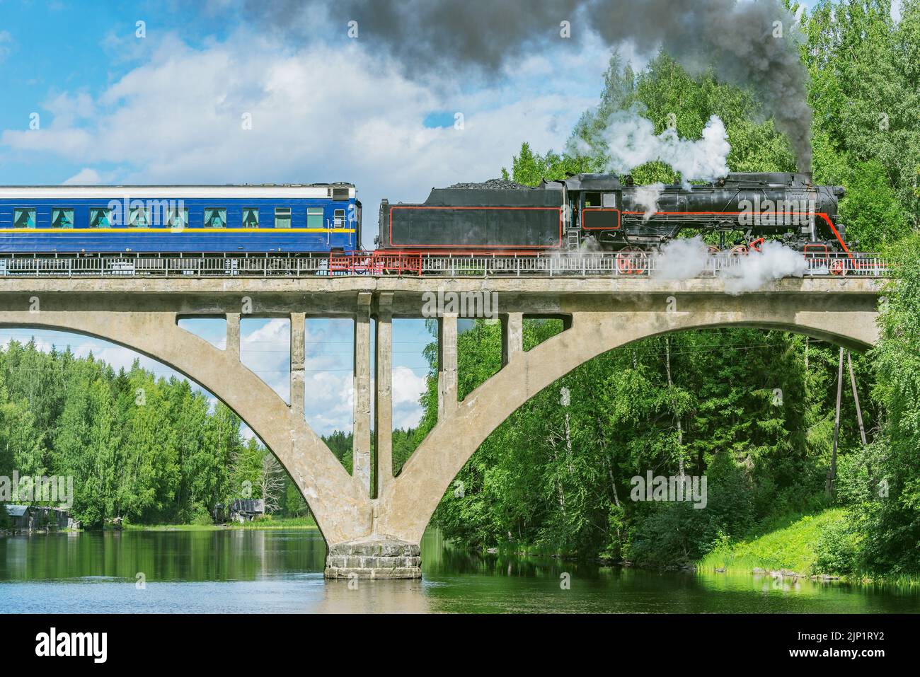 Retro steam train moves above the river Stock Photo - Alamy