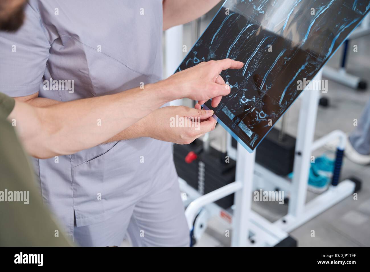 Doctor with patient examining x-rays of injuries Stock Photo - Alamy