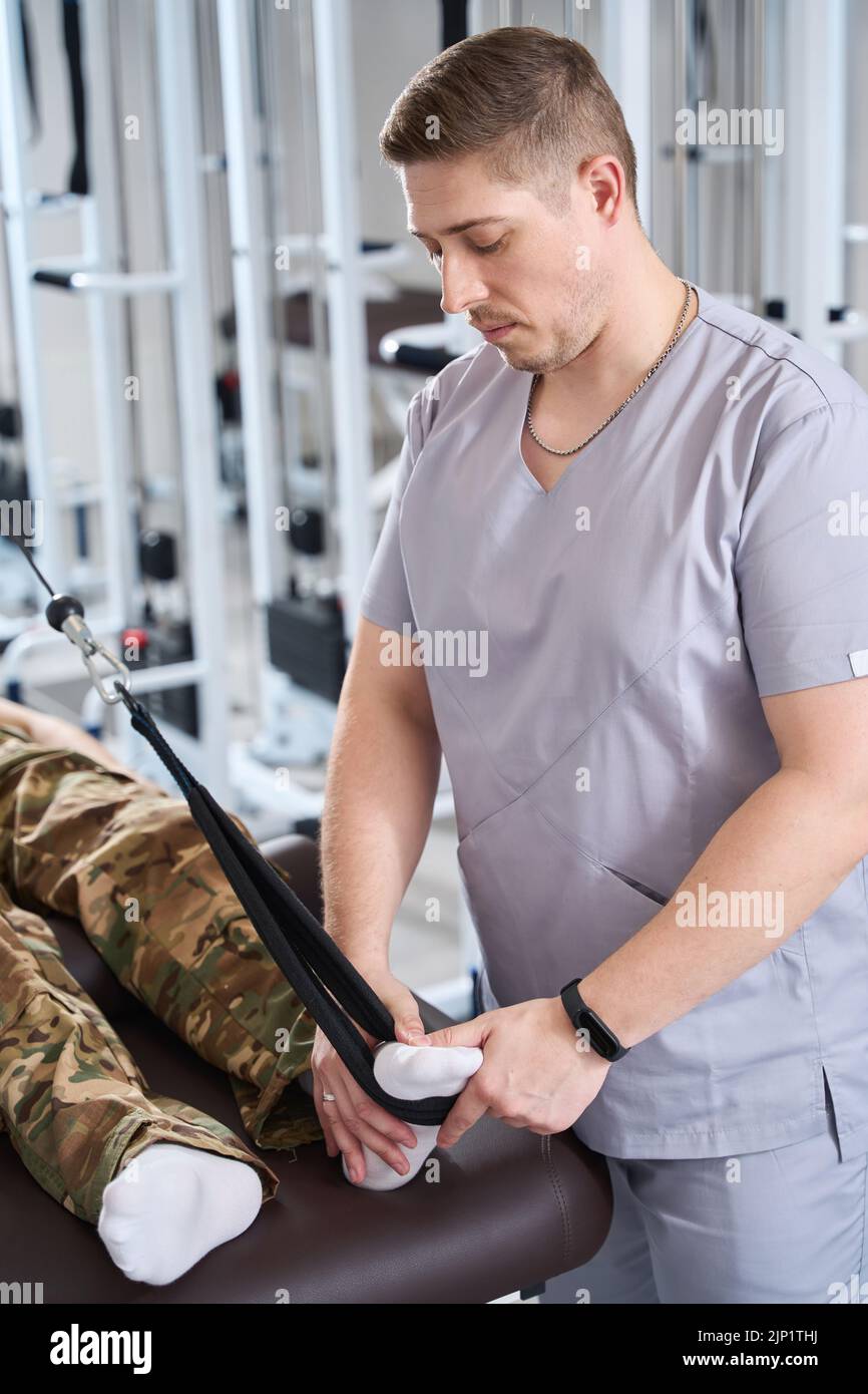 Doctor in a rehabilitation center works with a patient foot Stock Photo ...