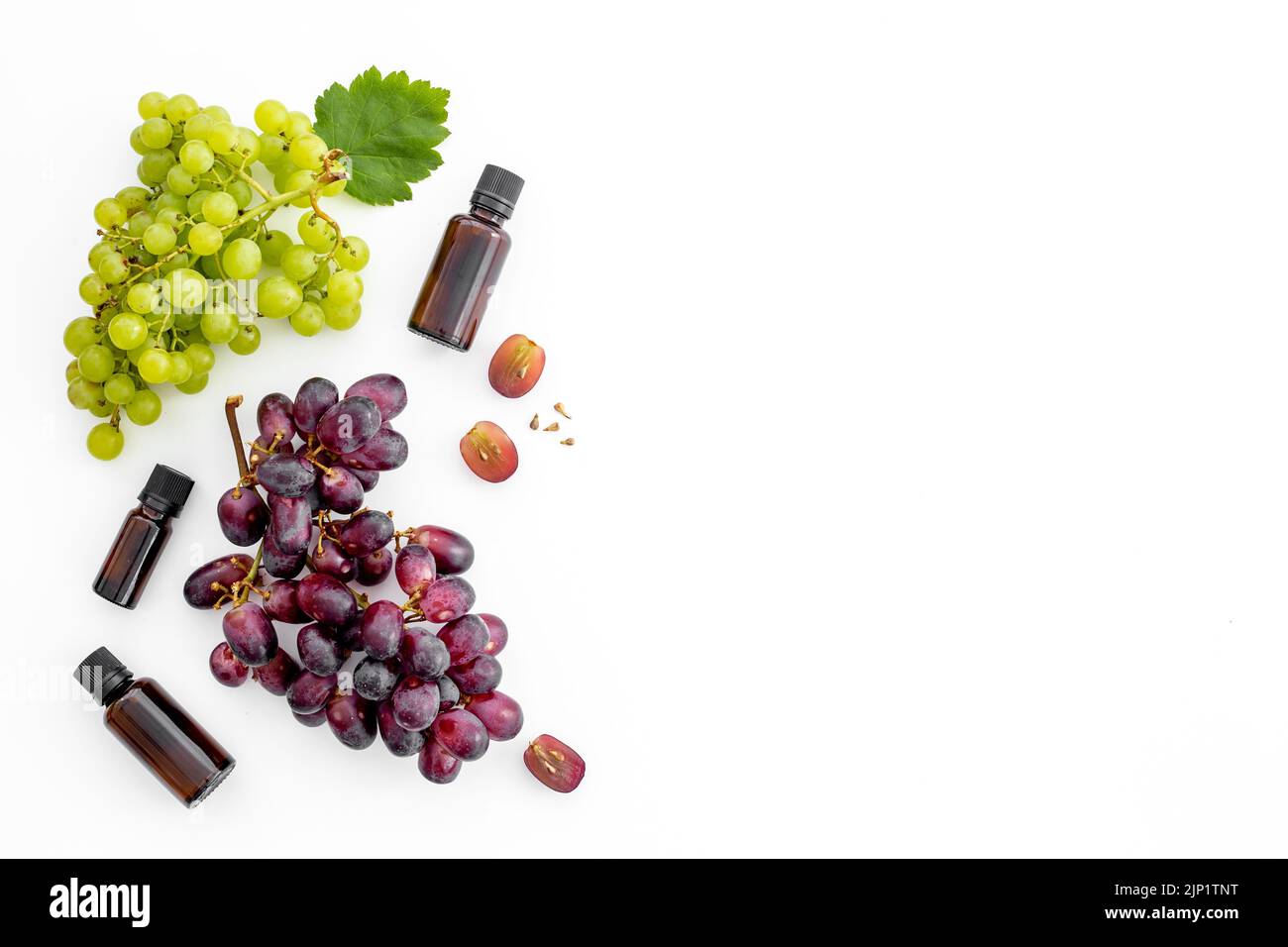 Grape seed oil in bottles with bunch of grapes. Eco cosmetic product ...