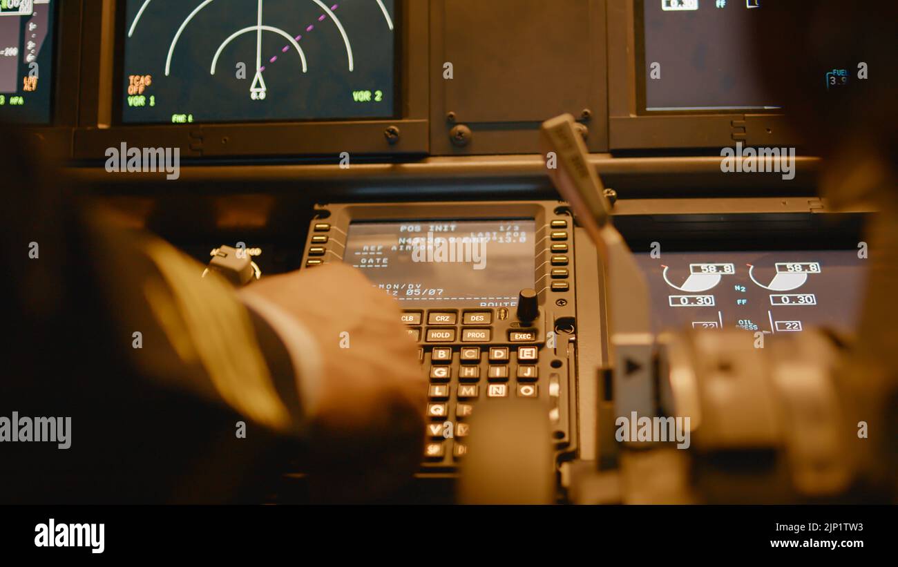 Captain inserting destination coordinates on cabin dashboard, using ...