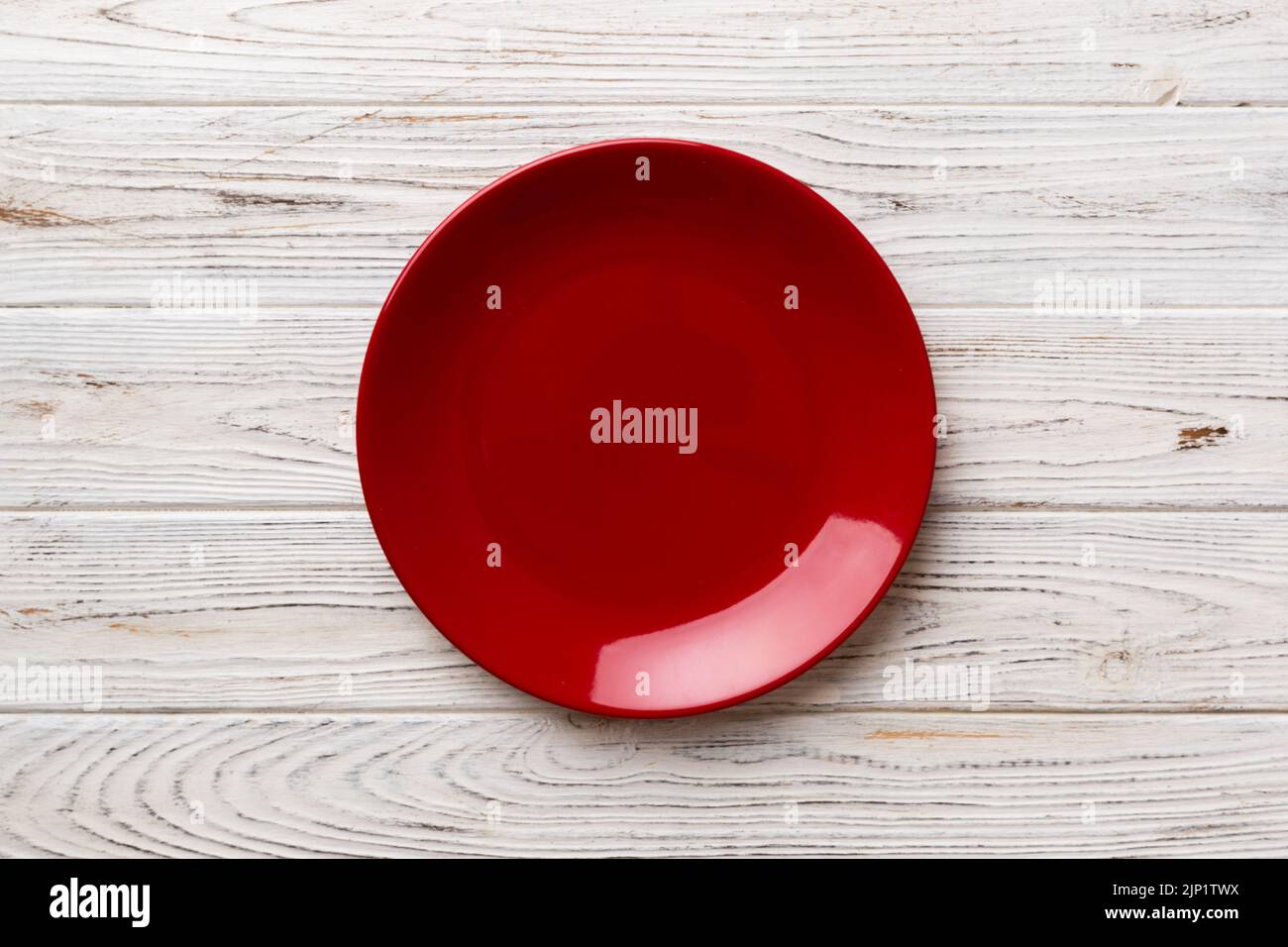 Top view of empty red plate on wooden background. Empty space for your ...