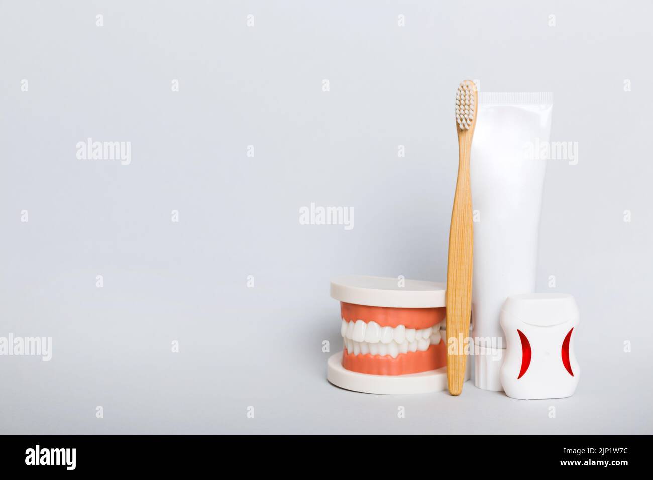 Mouthwash and other oral hygiene products on colored table top view ...