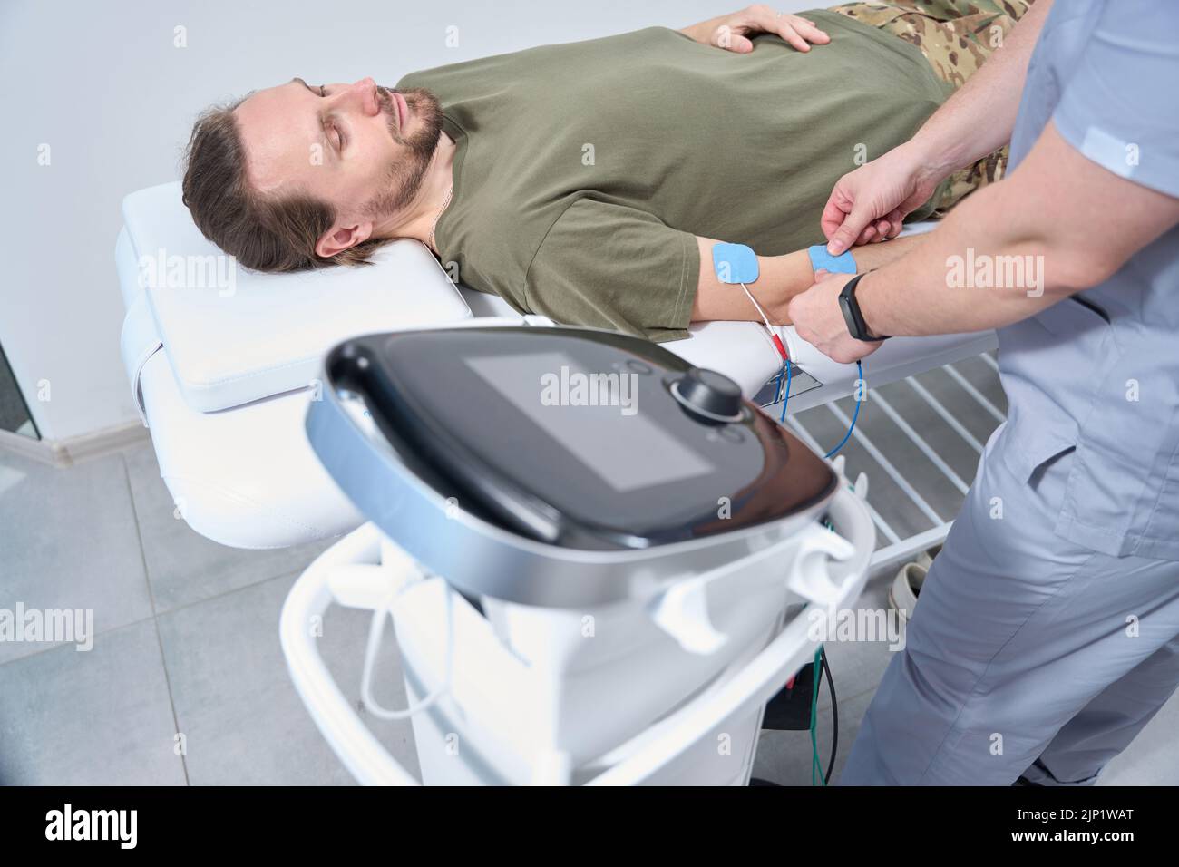 Patient is attached electrodes to the arm in amilitary hospital Stock ...
