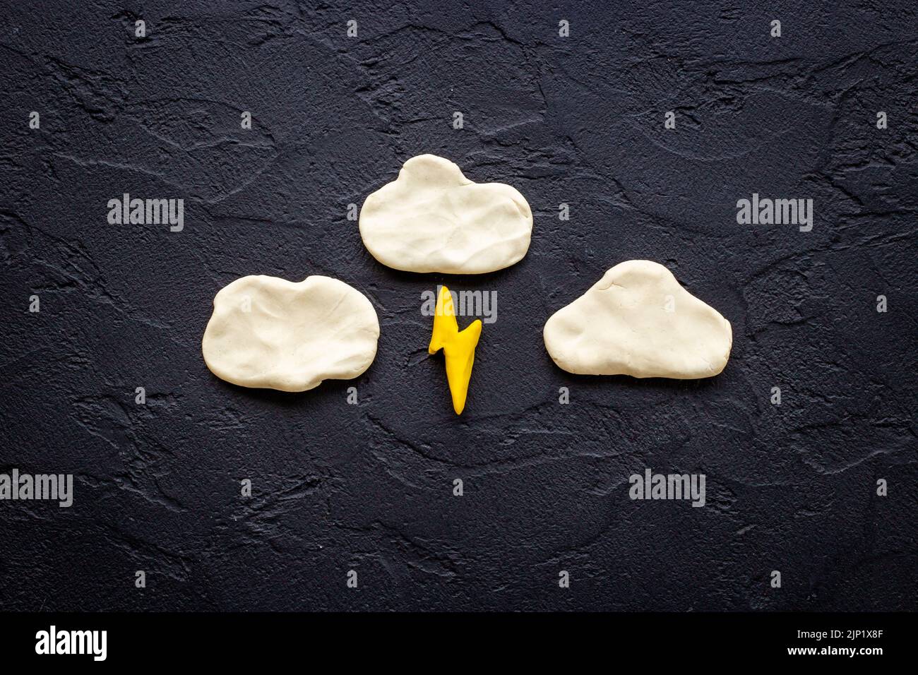 Plasticine clouds with lightning thunderbolt. Weather forecast concept ...