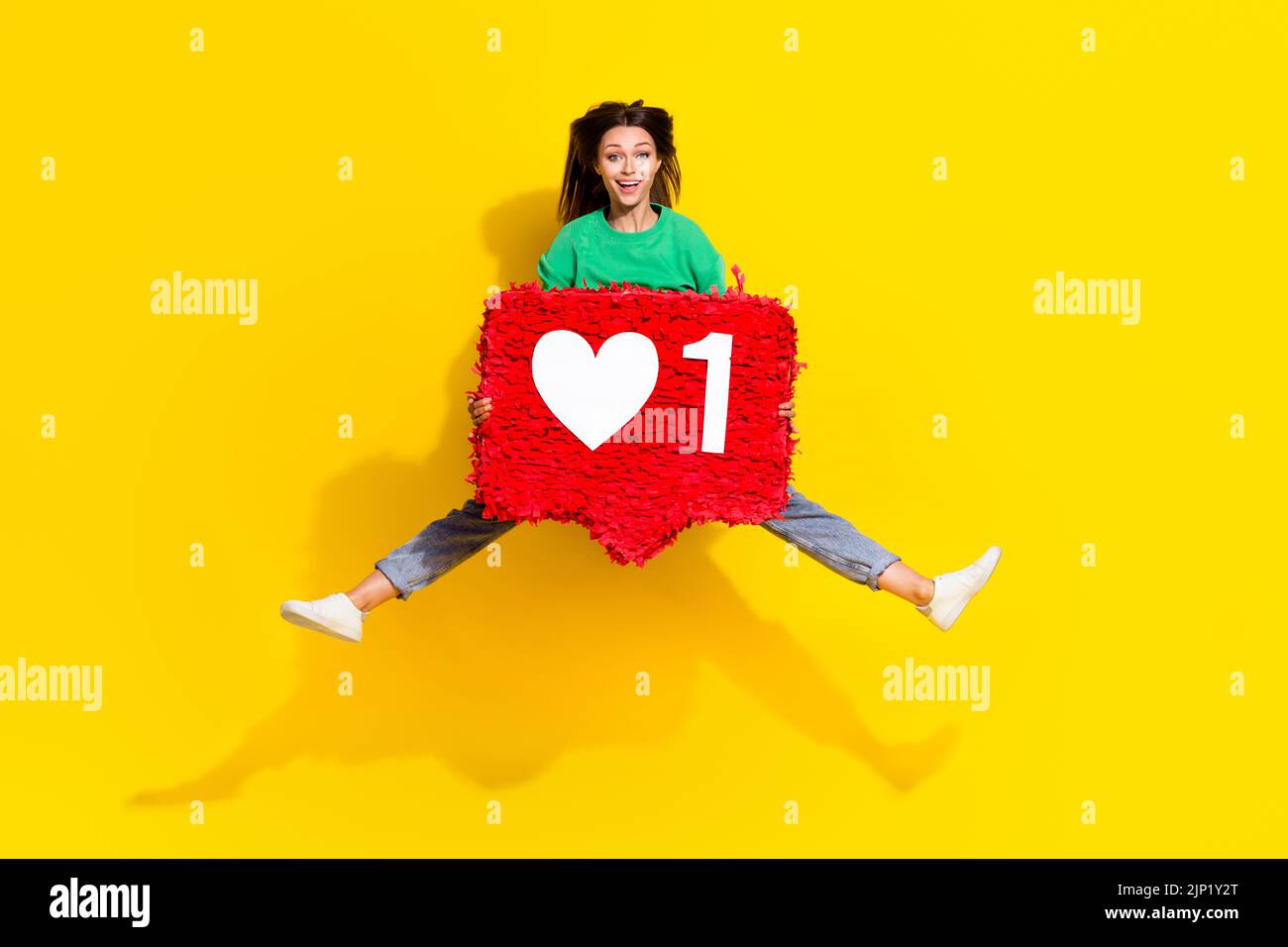 Full size portrait of excited pretty girl jump arms hold big like ...