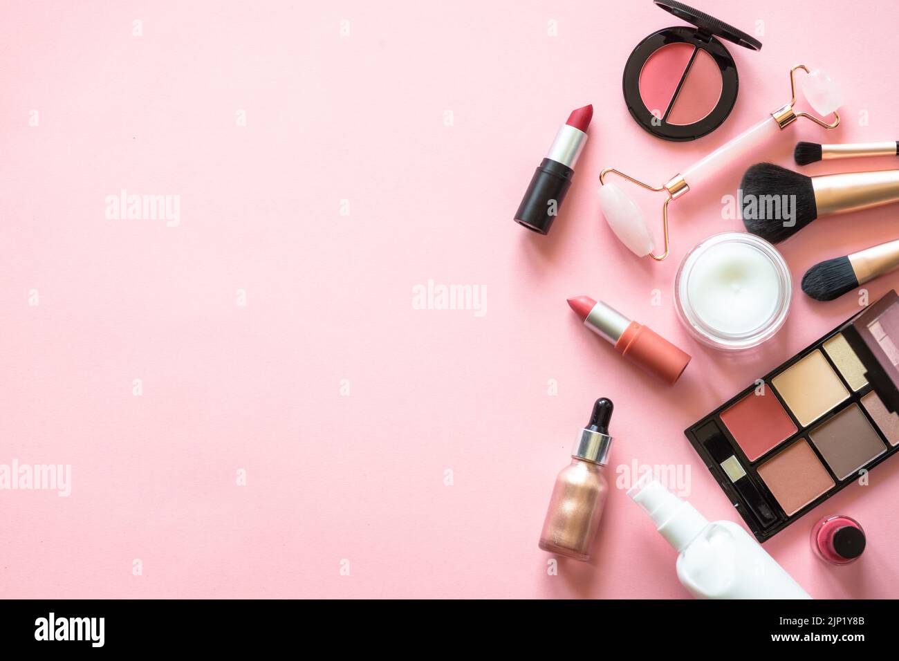 Makeup professional cosmetics on pink background Stock Photo - Alamy