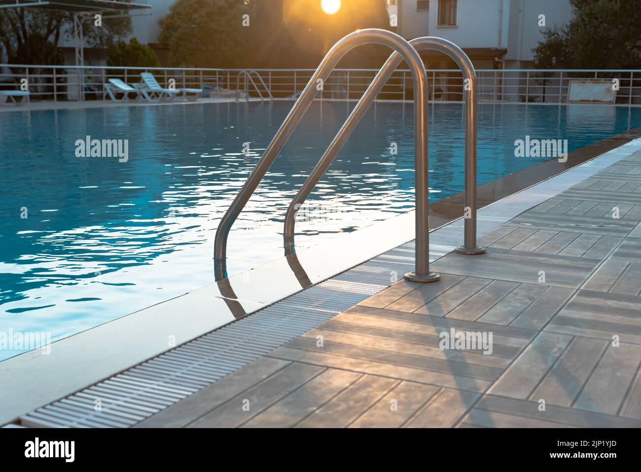 Swimming pool with stair and wooden deck at hotel. High quality photo ...