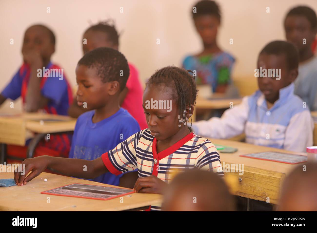 TORO, SENEGAL - FEB 4: A schoolgirl in her classroom with a chalkboard ...