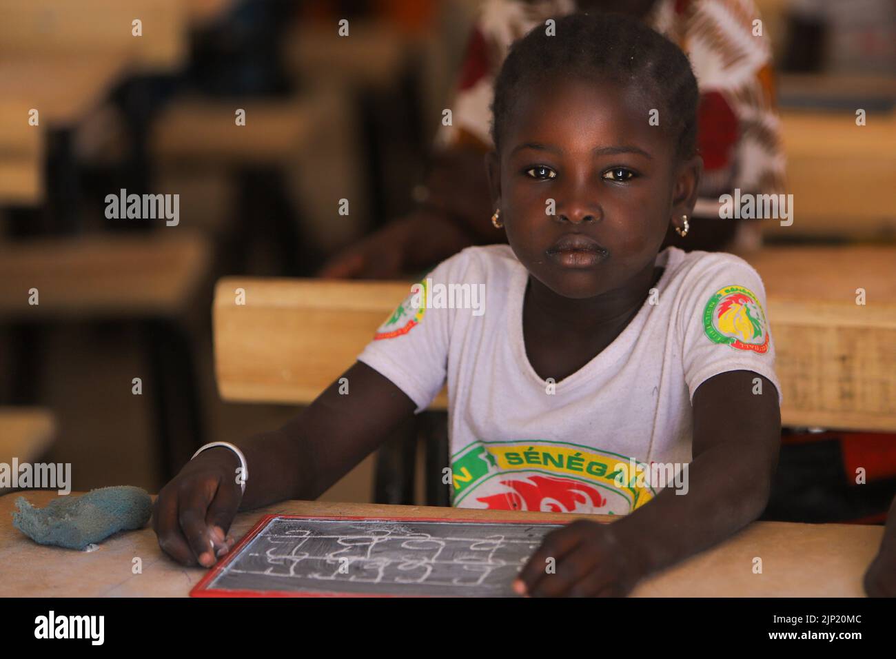 TORO, SENEGAL - FEB 4: A schoolgirl in her classroom with a chalkboard ...