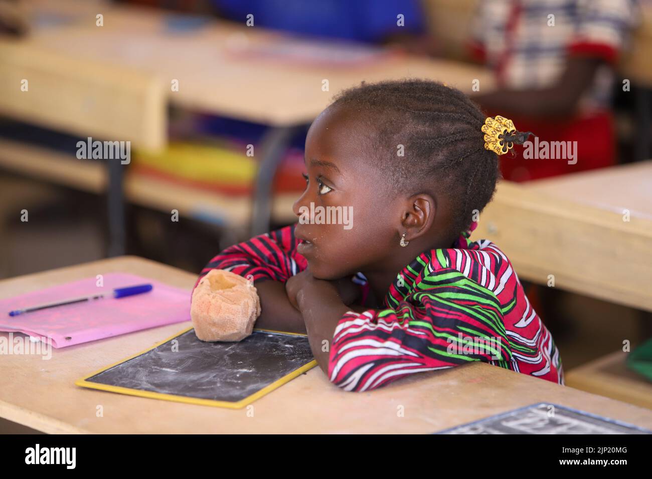 TORO, SENEGAL - FEB 4: A schoolgirl in her classroom with a chalkboard ...